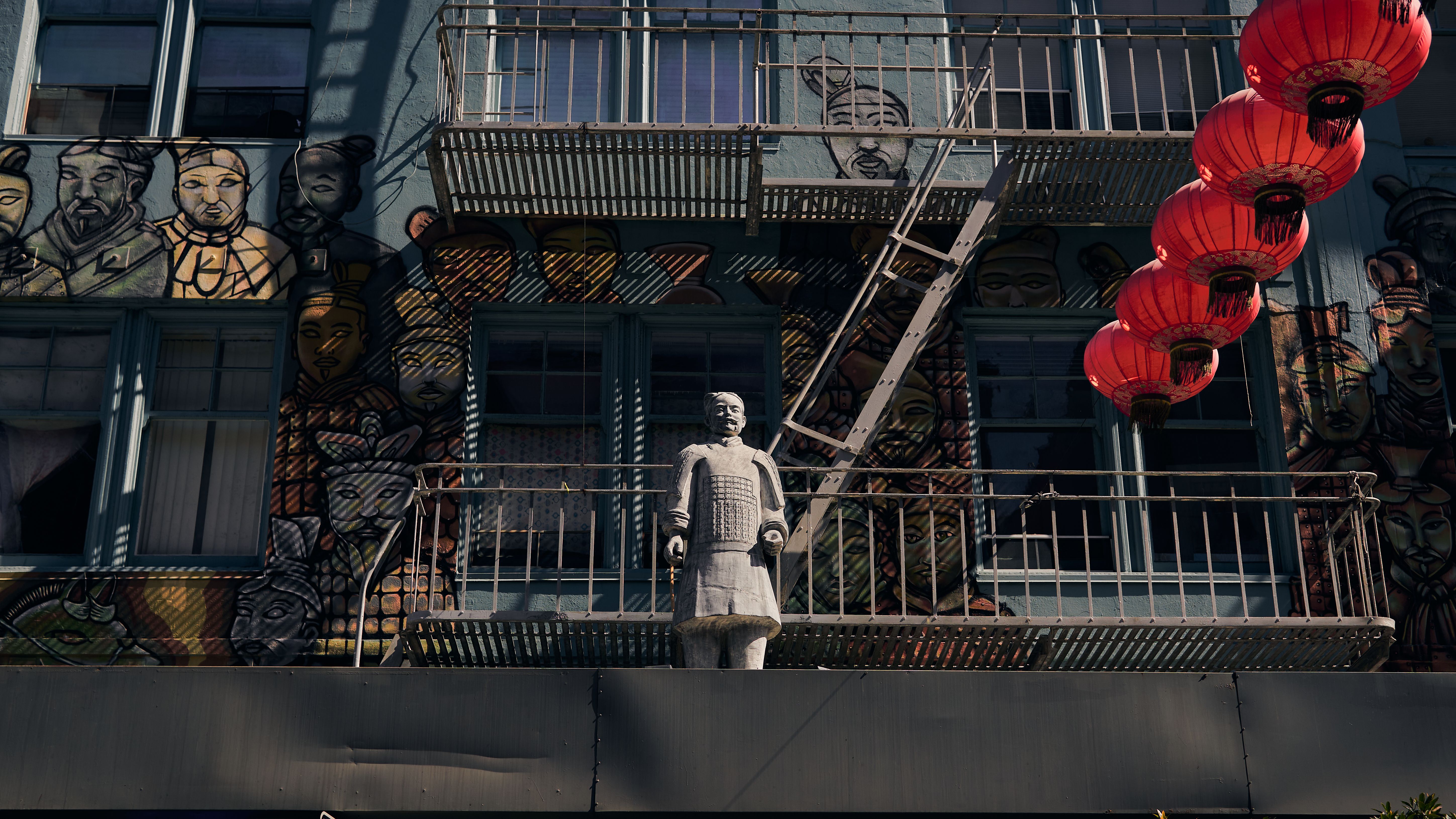 Chinese Statue on Mural over Balconies · Free Stock Photo