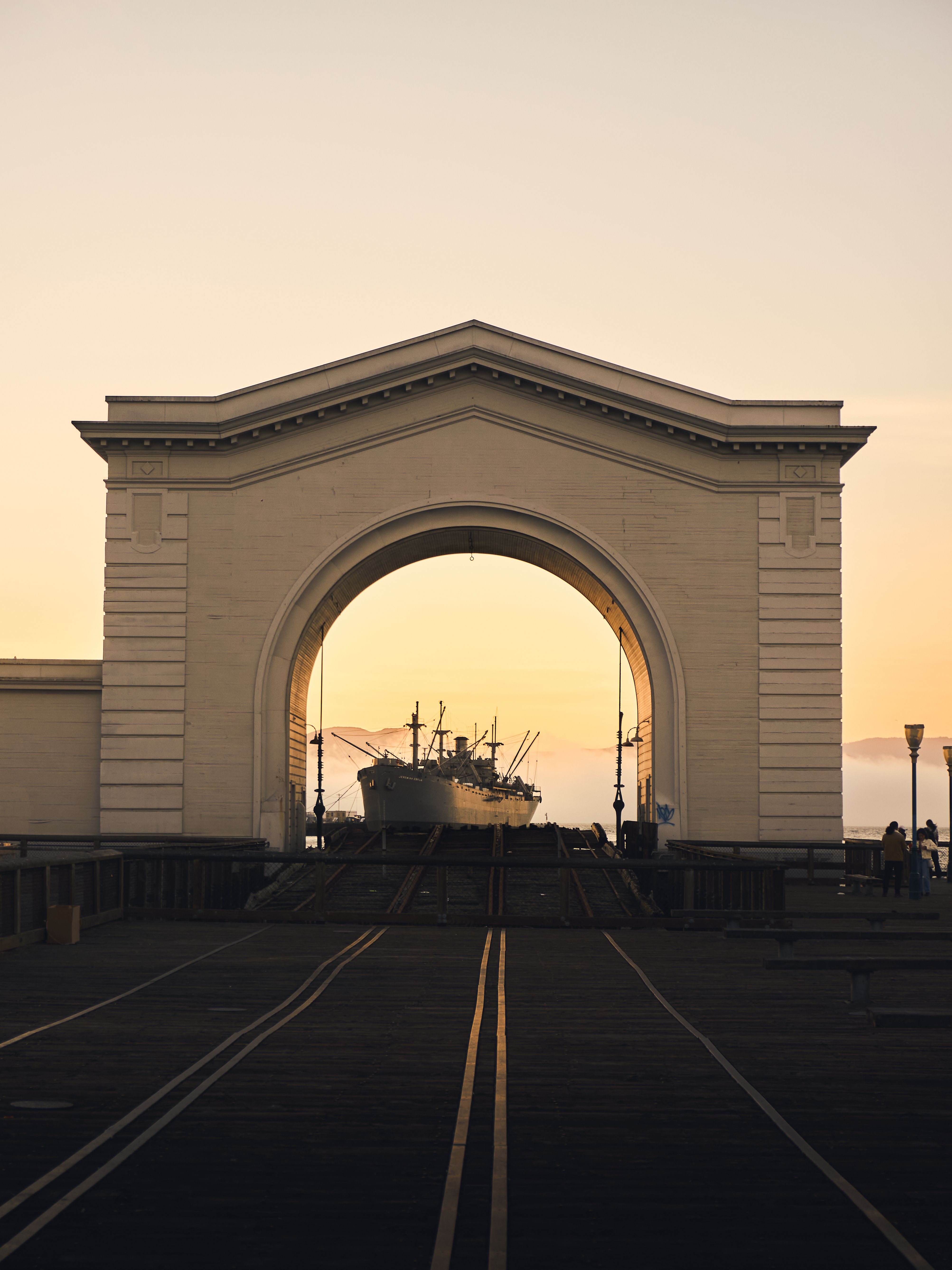 A ship is docked at the entrance to an arch · Free Stock Photo