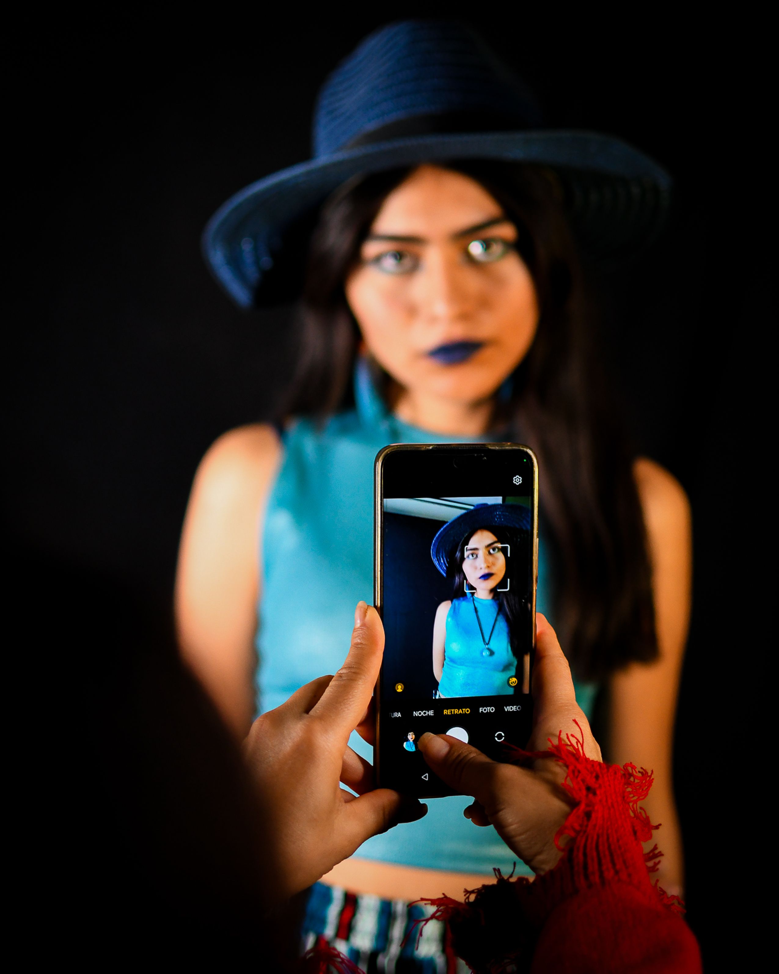 Woman Holding a Phone in a Studio · Free Stock Photo
