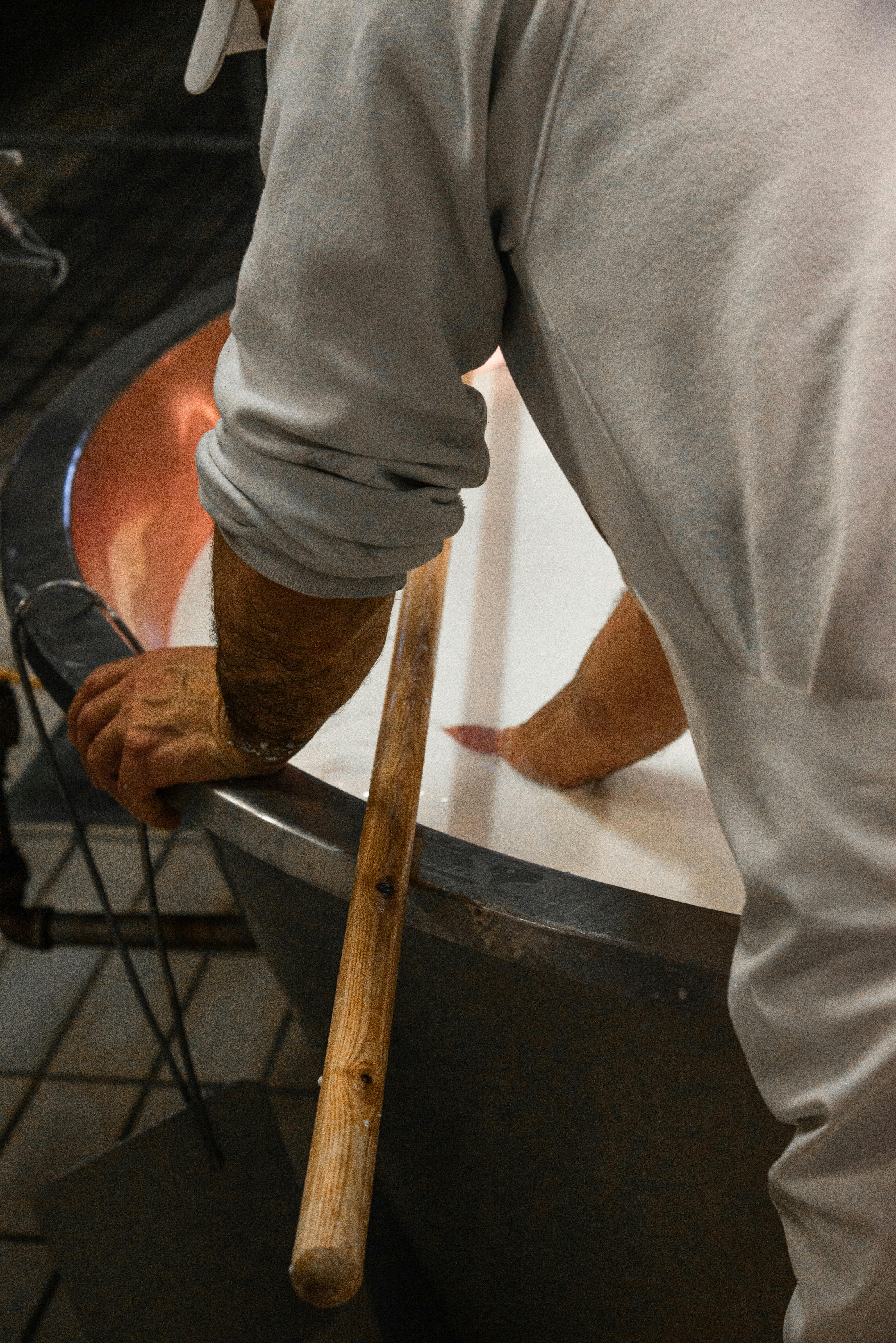 Man Bending over Pot with Foam · Free Stock Photo