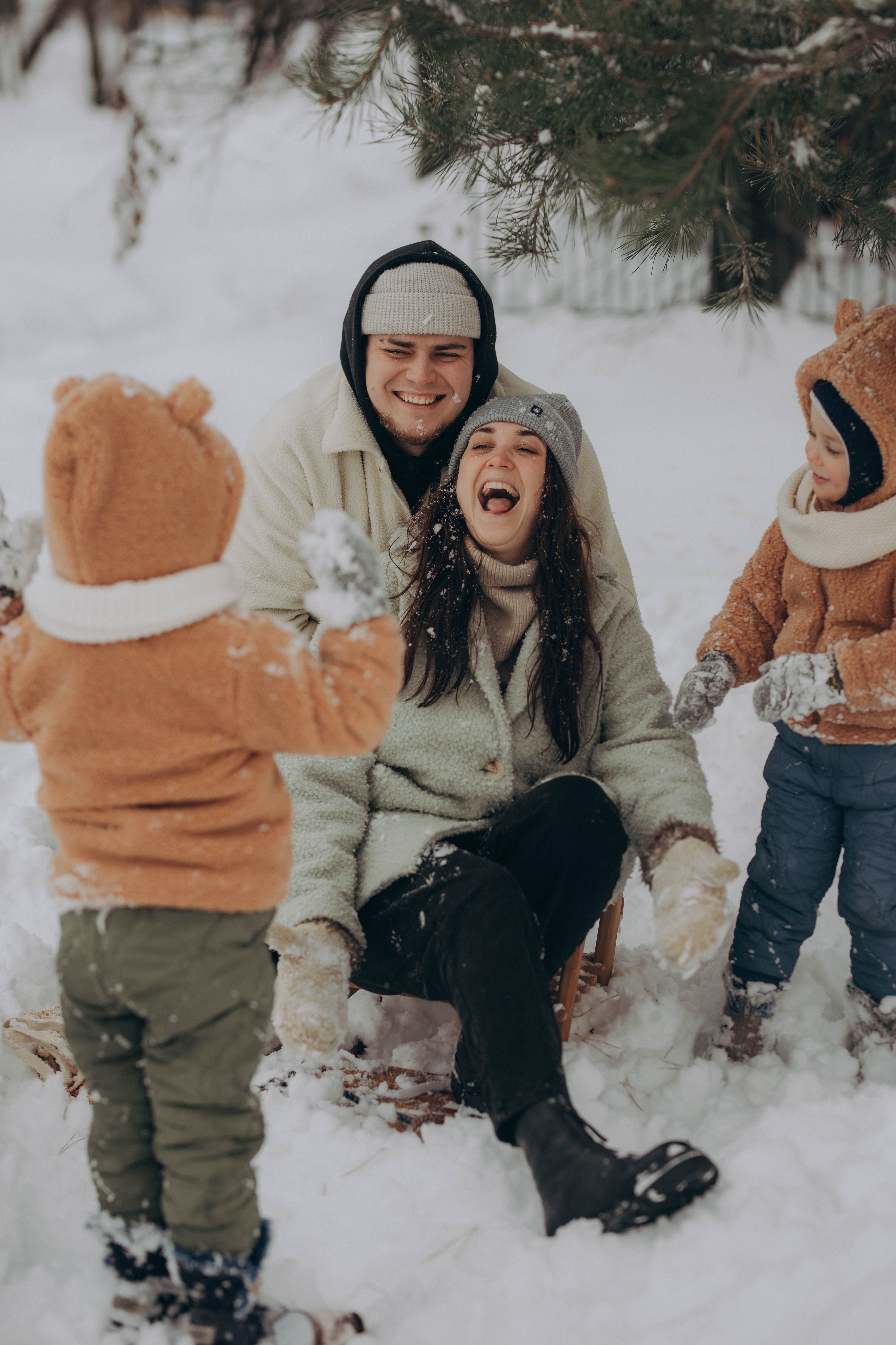 Smiling Family Playing in Snow · Free Stock Photo