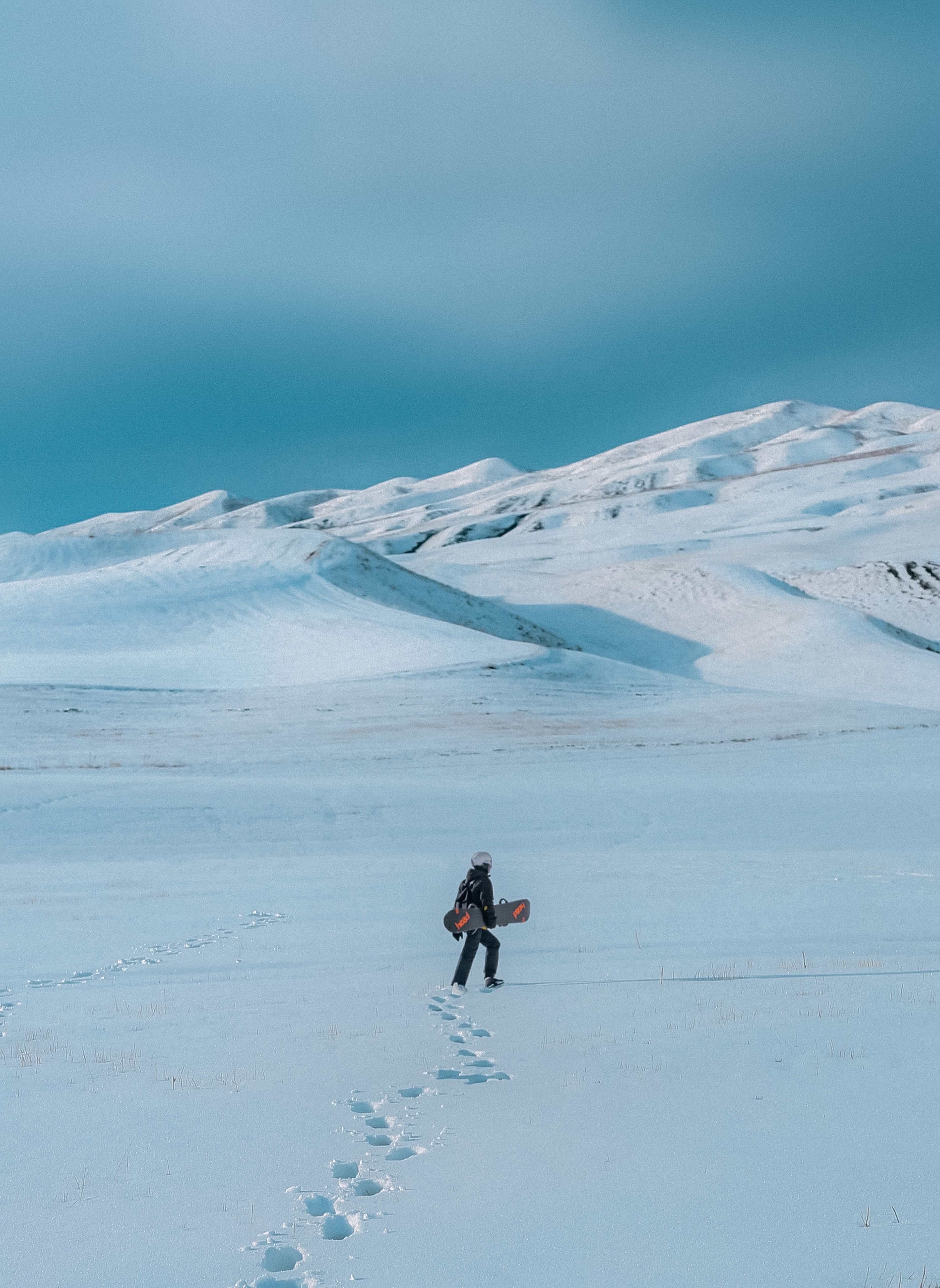 Person Walking with Snowboard in Snow · Free Stock Photo