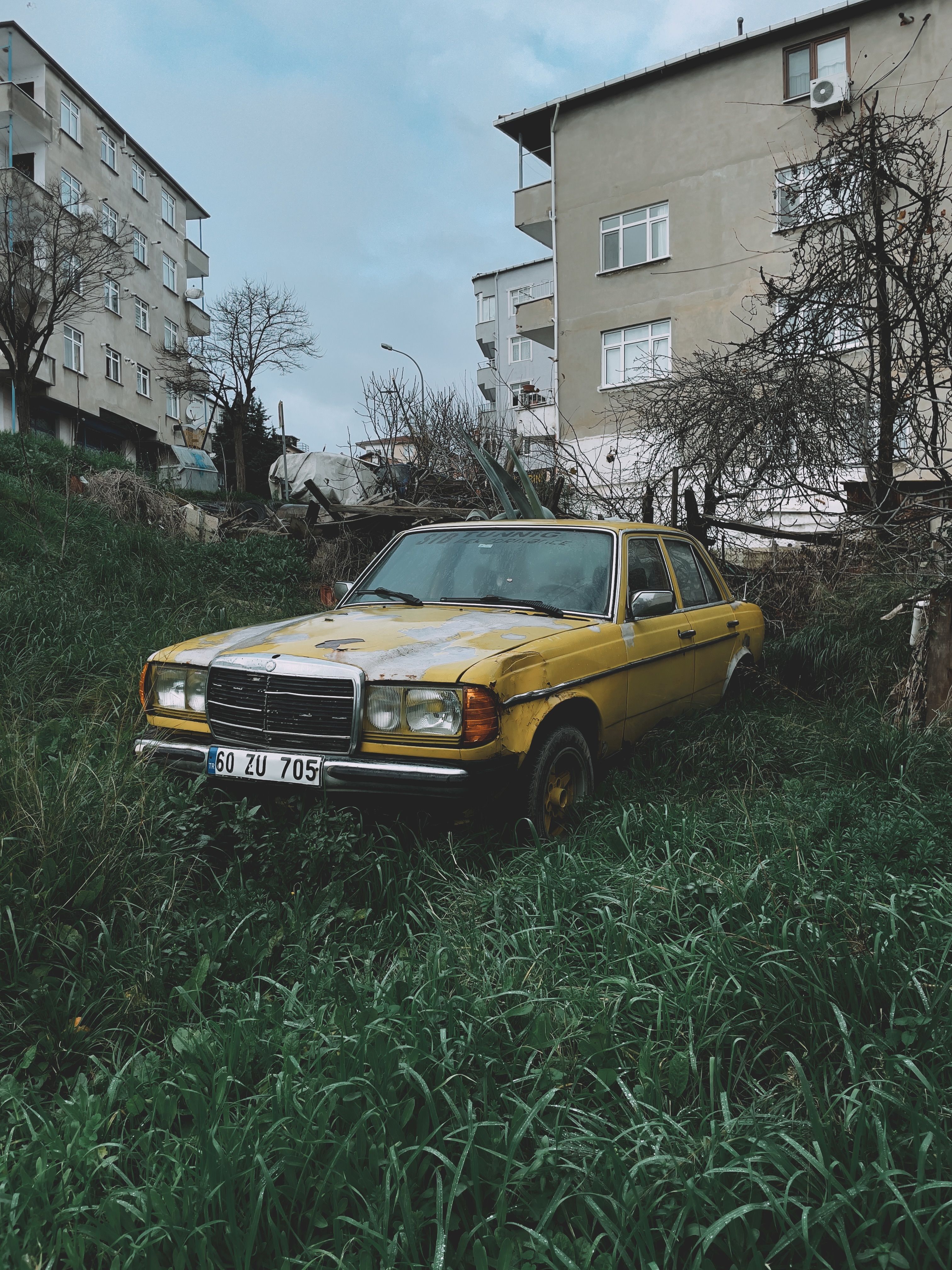 Yellow Rusty Car on Estate · Free Stock Photo