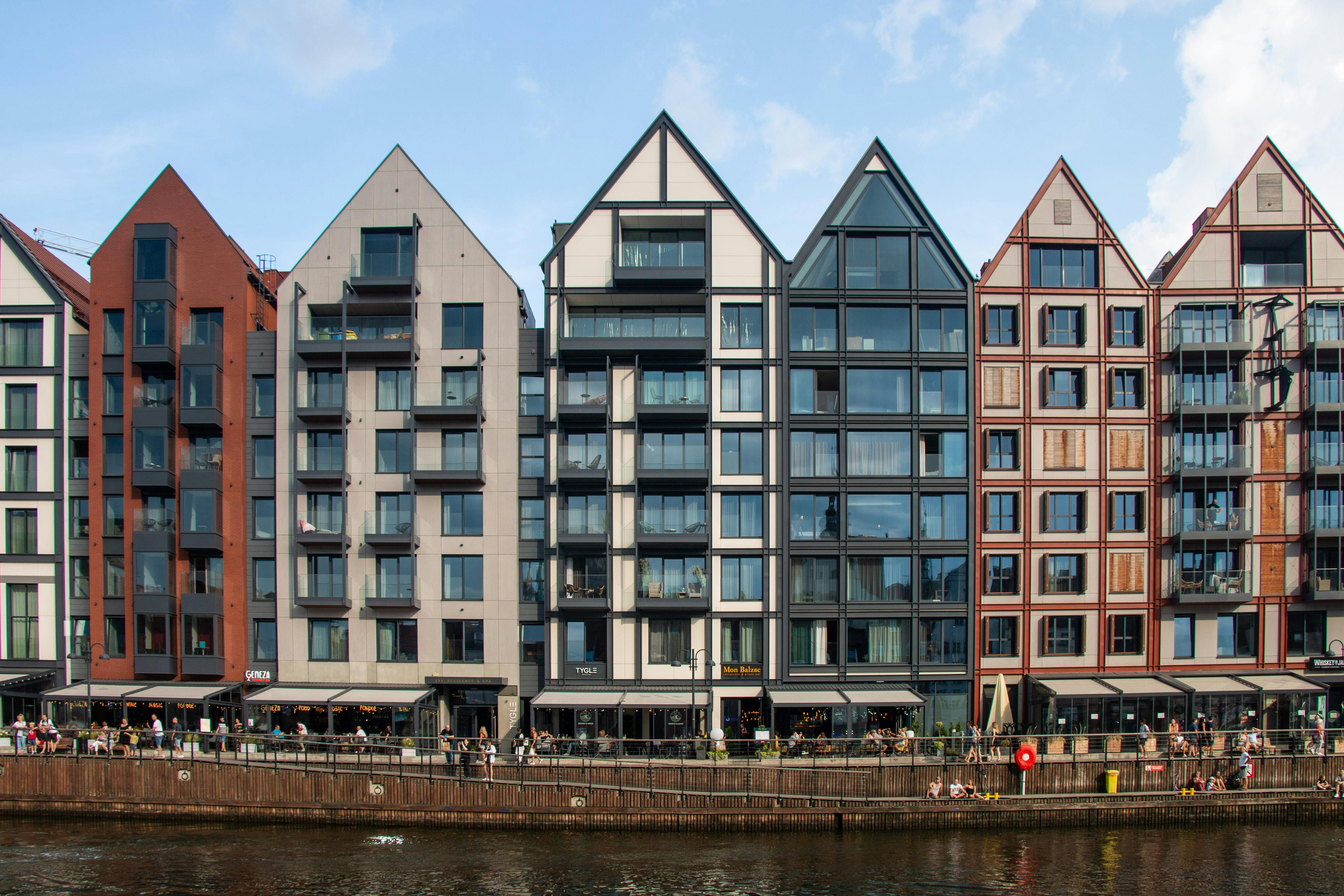 Modern Tenements by River in Gdansk · Free Stock Photo