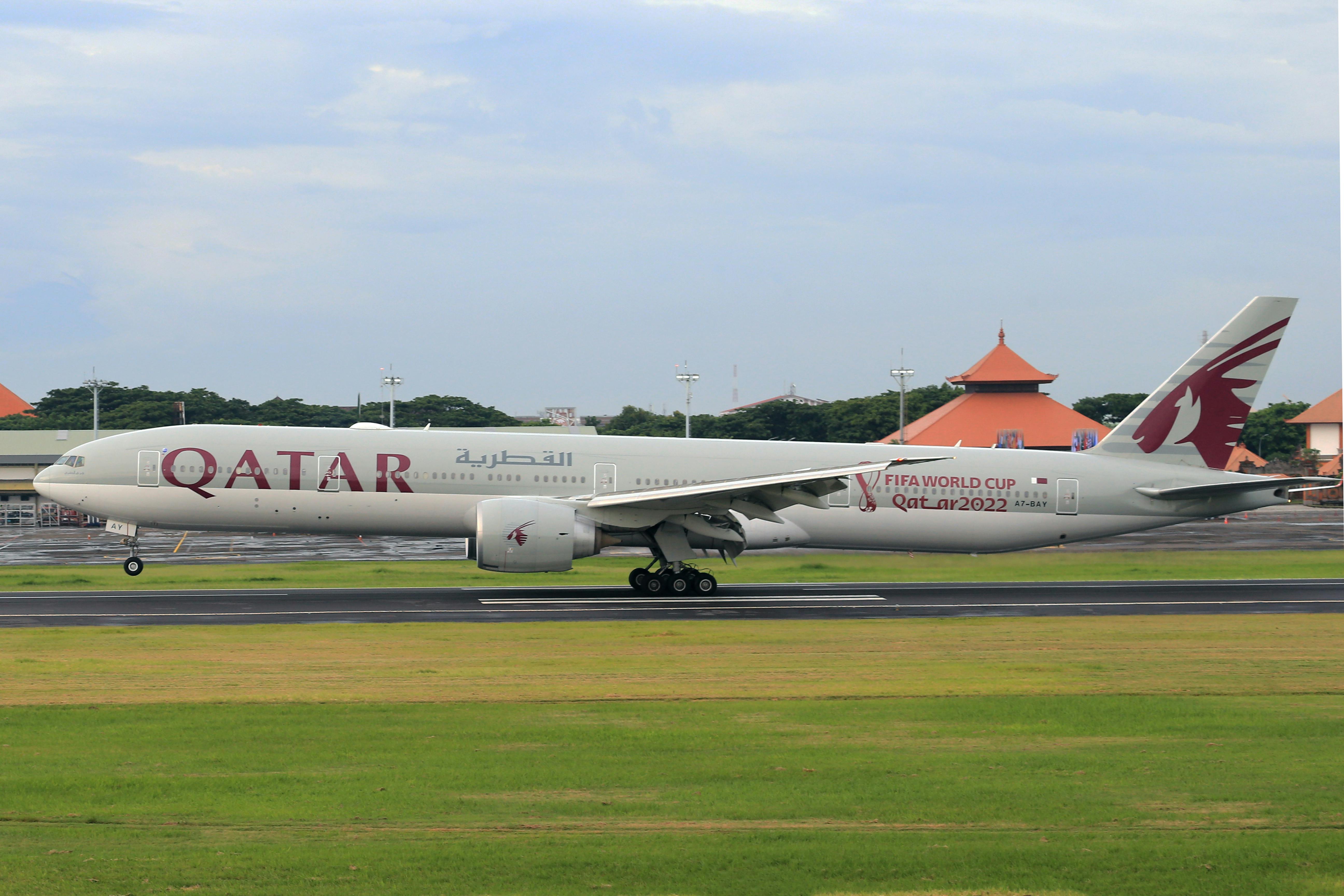 A qatar airways plane on the runway at an airport · Free Stock Photo