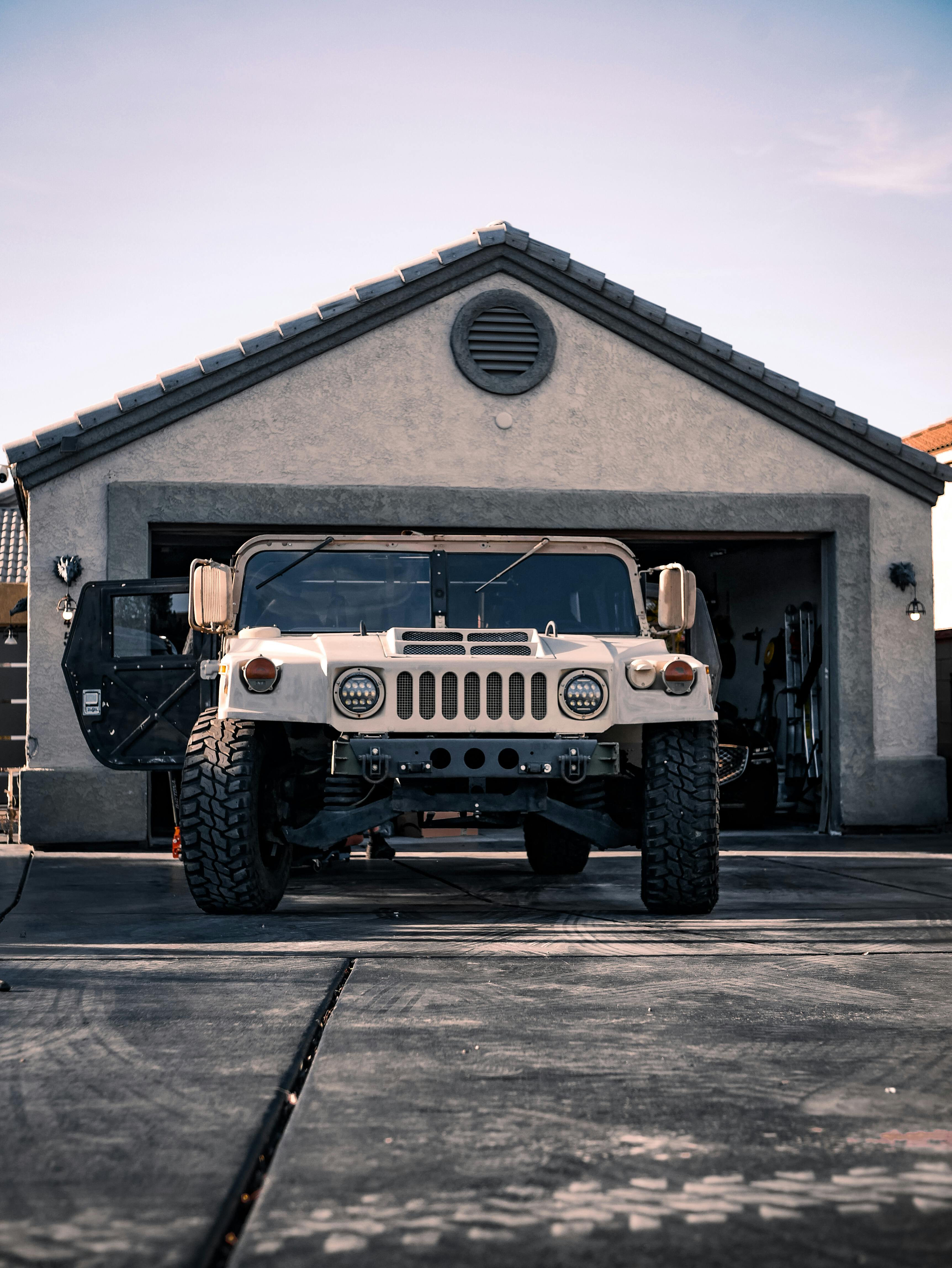 A Hummer H1 Parked in Front of a Garage · Free Stock Photo