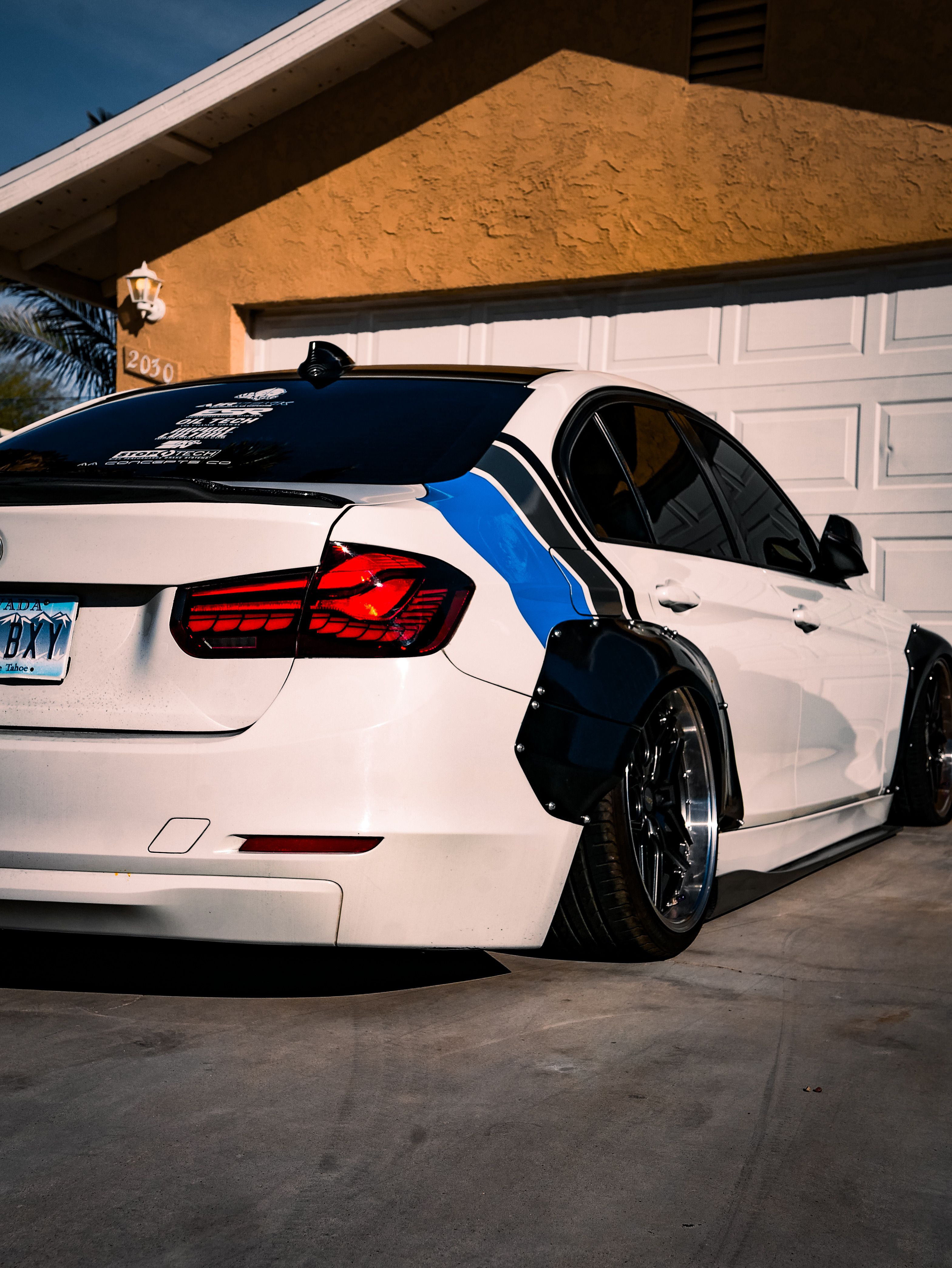 A Modern Modified BMW F30 Parked on a Driveway · Free Stock Photo