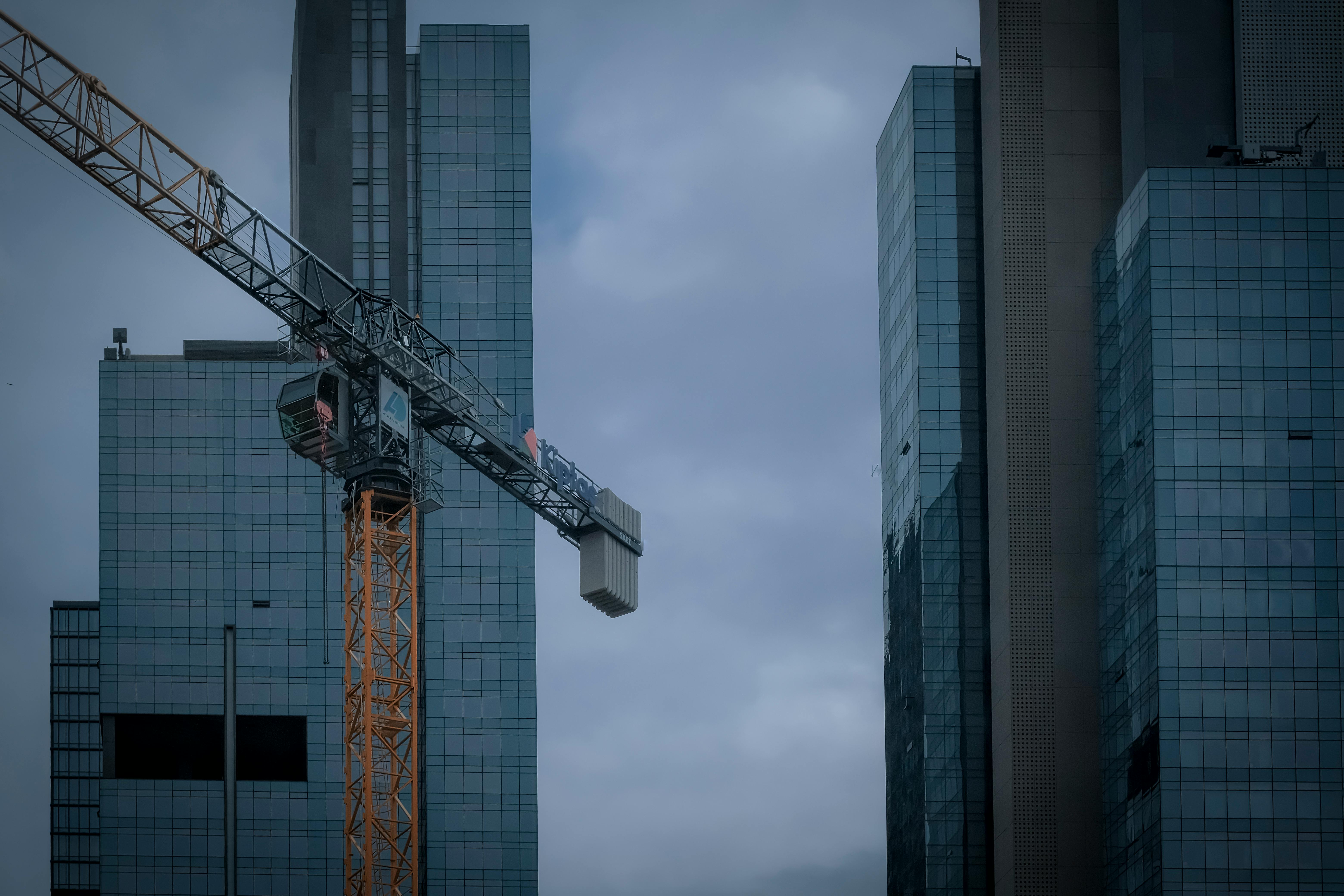 Industrial Crane against Office Skyscrapers · Free Stock Photo