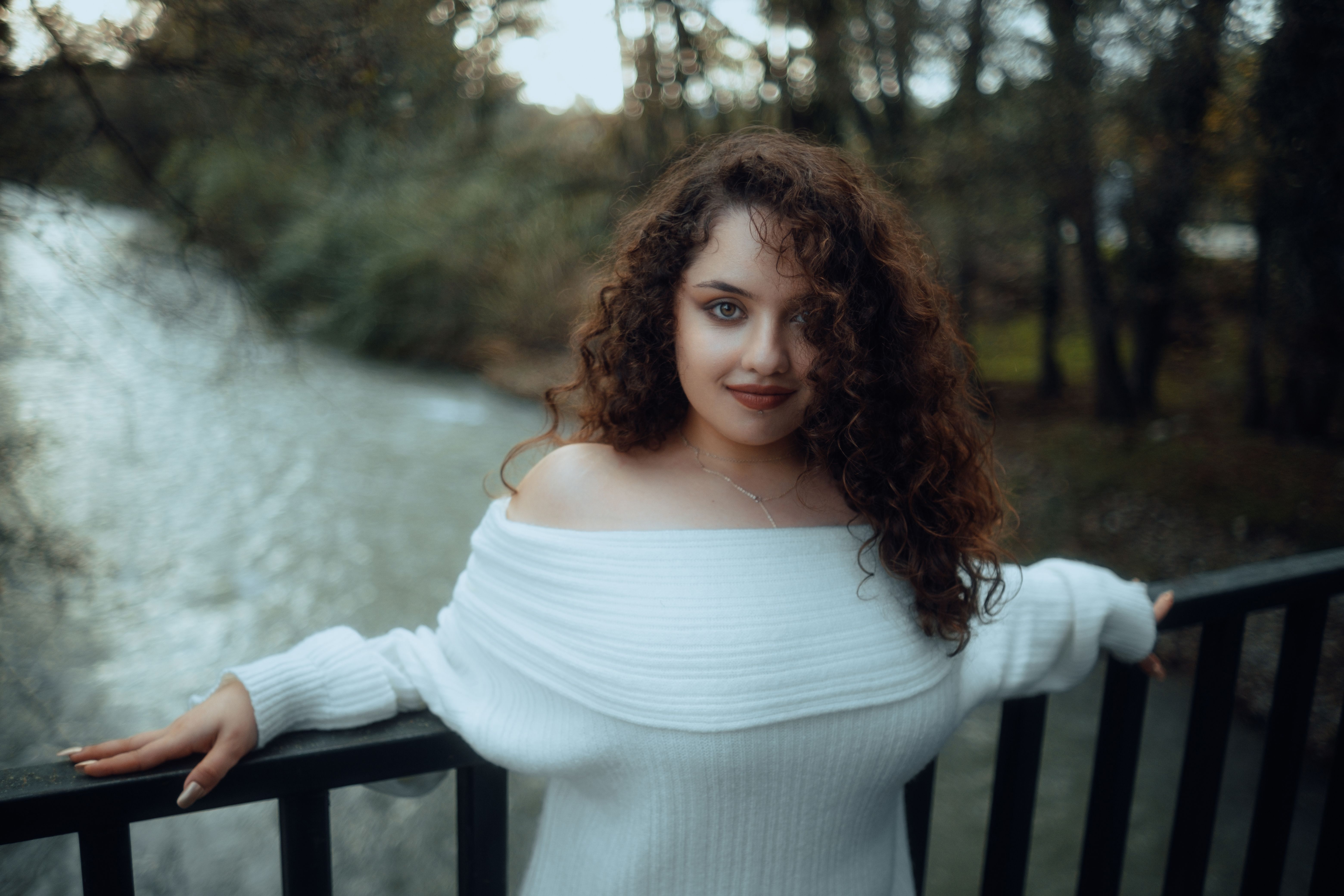 Woman with Curly Hair Standing with River behind · Free Stock Photo