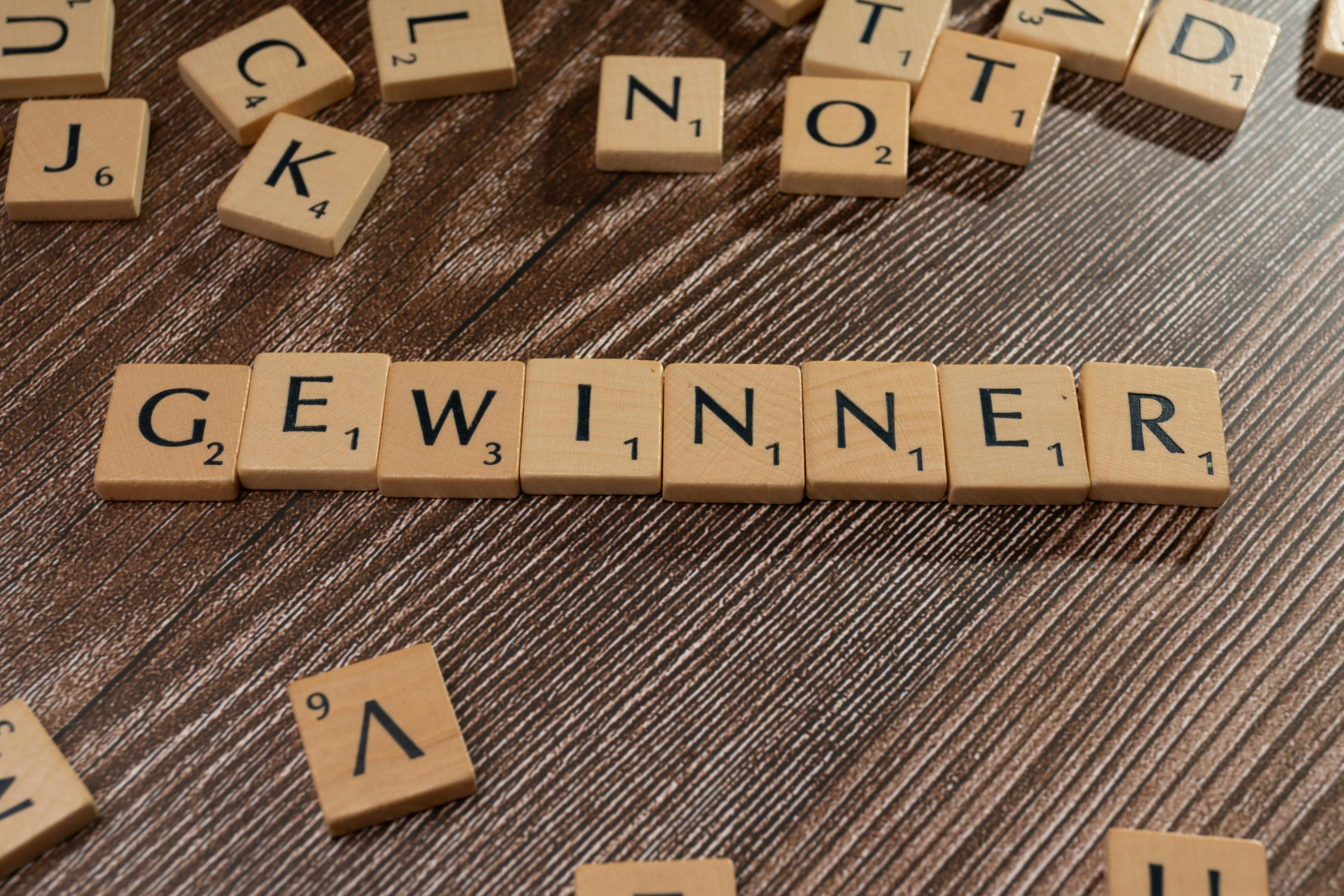 Scrabble letters spelling the word winner on a wooden table · Free ...