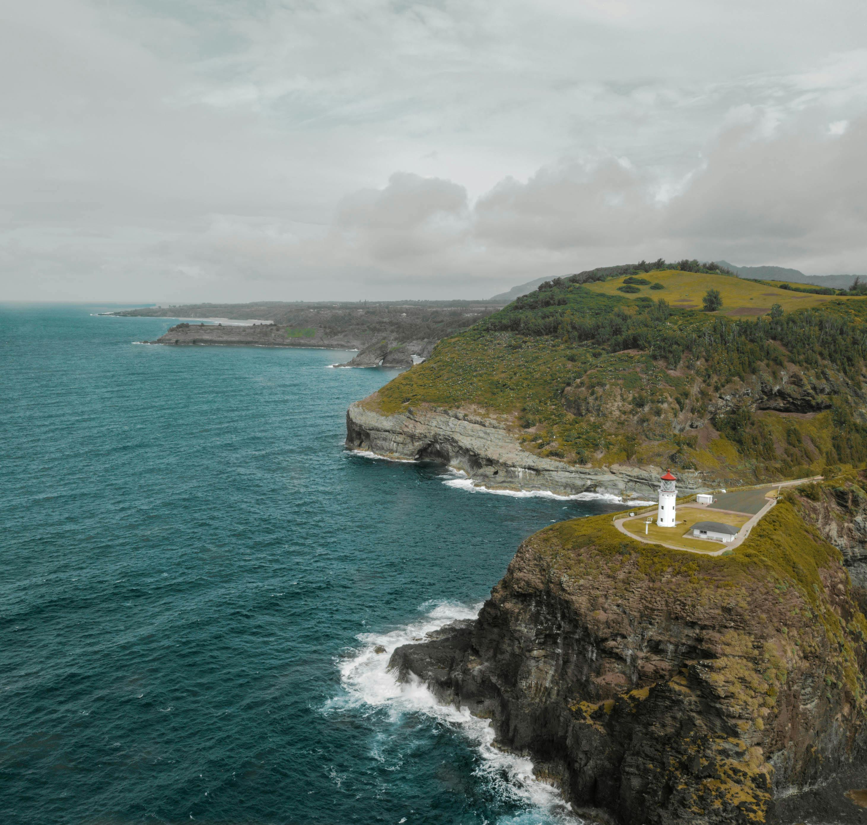 White Lighthouse on Cliff · Free Stock Photo