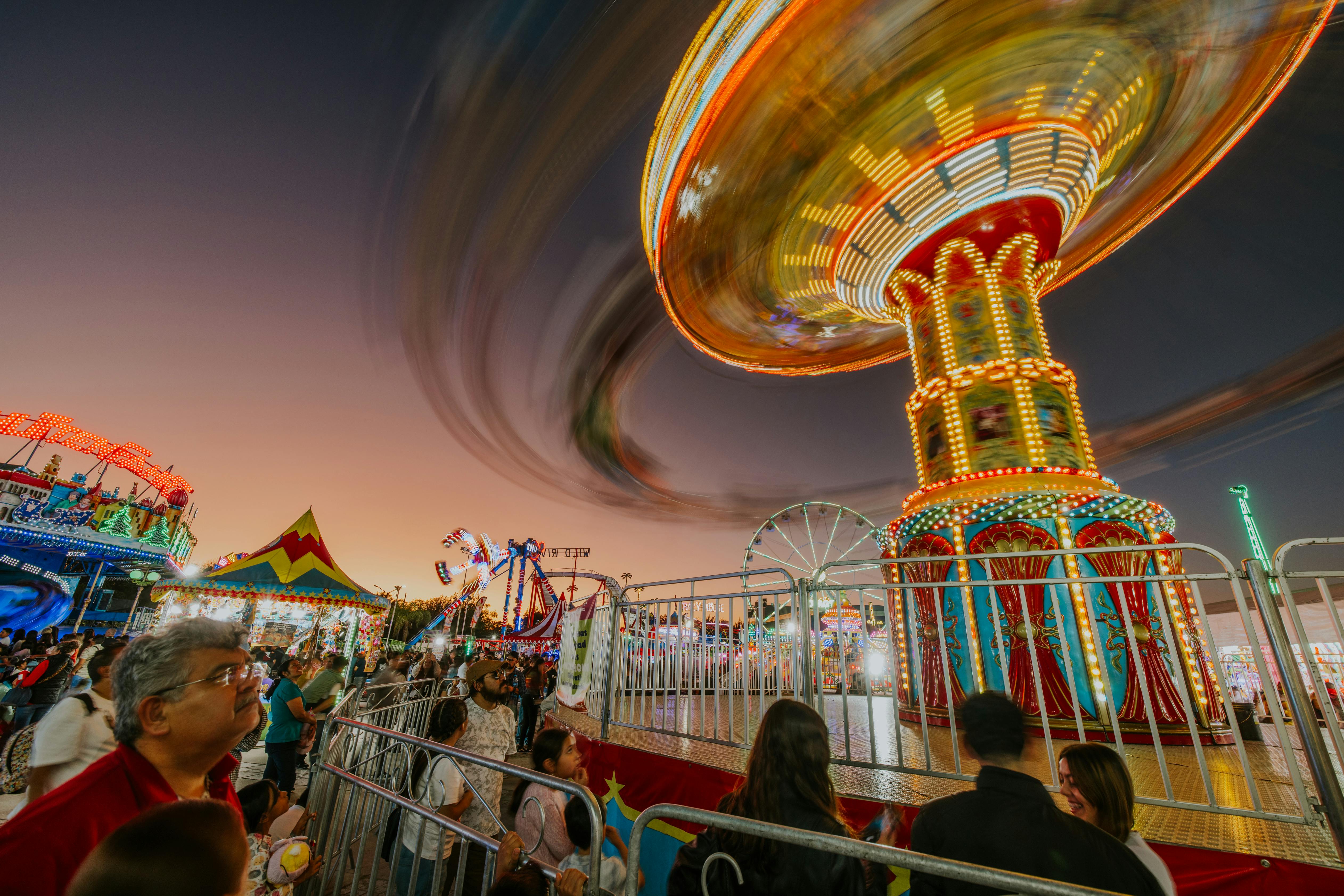 People near Carousel at Amusement Park · Free Stock Photo