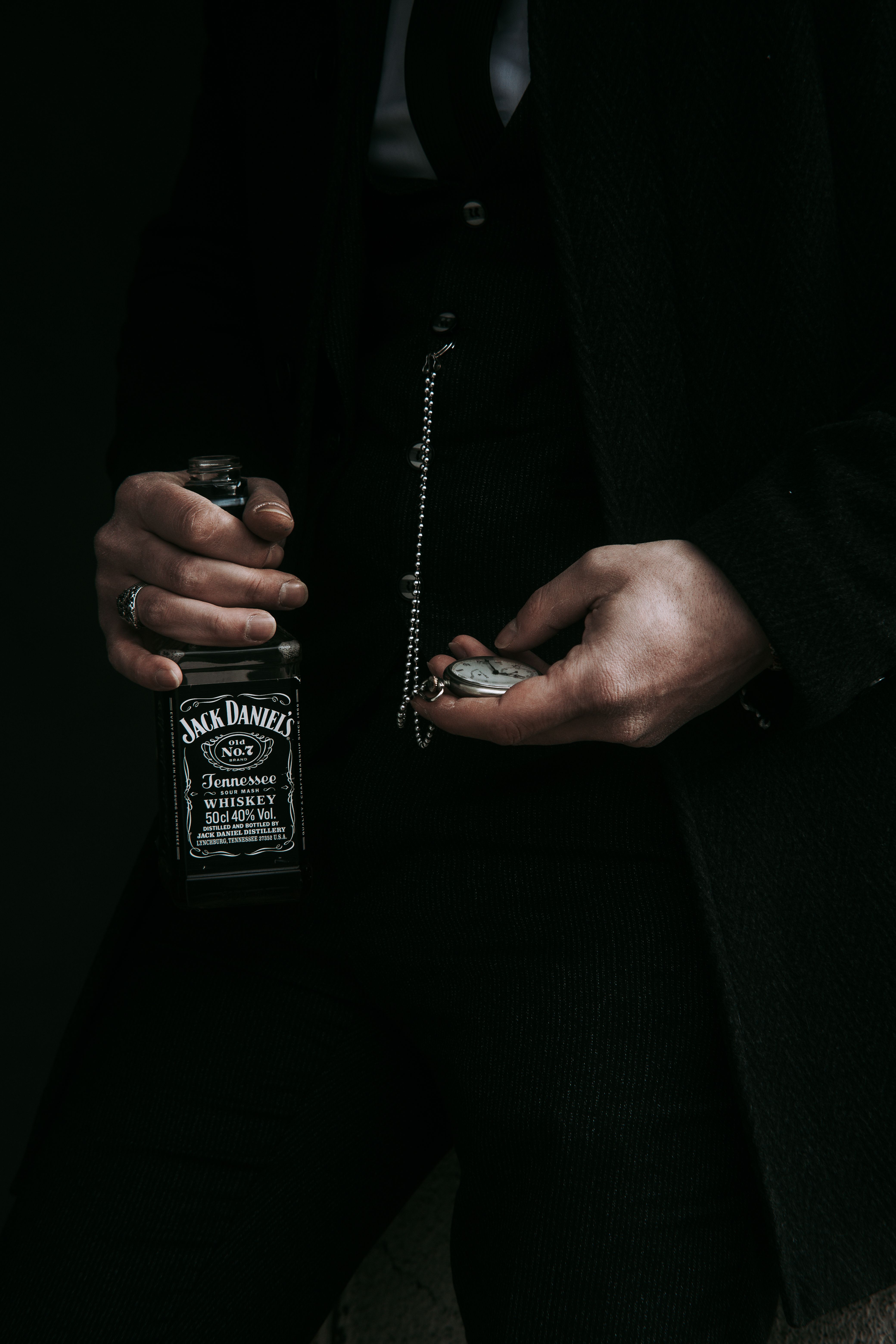 Checking the Time on Pocket Watch and Drinking Jack Daniels from a ...
