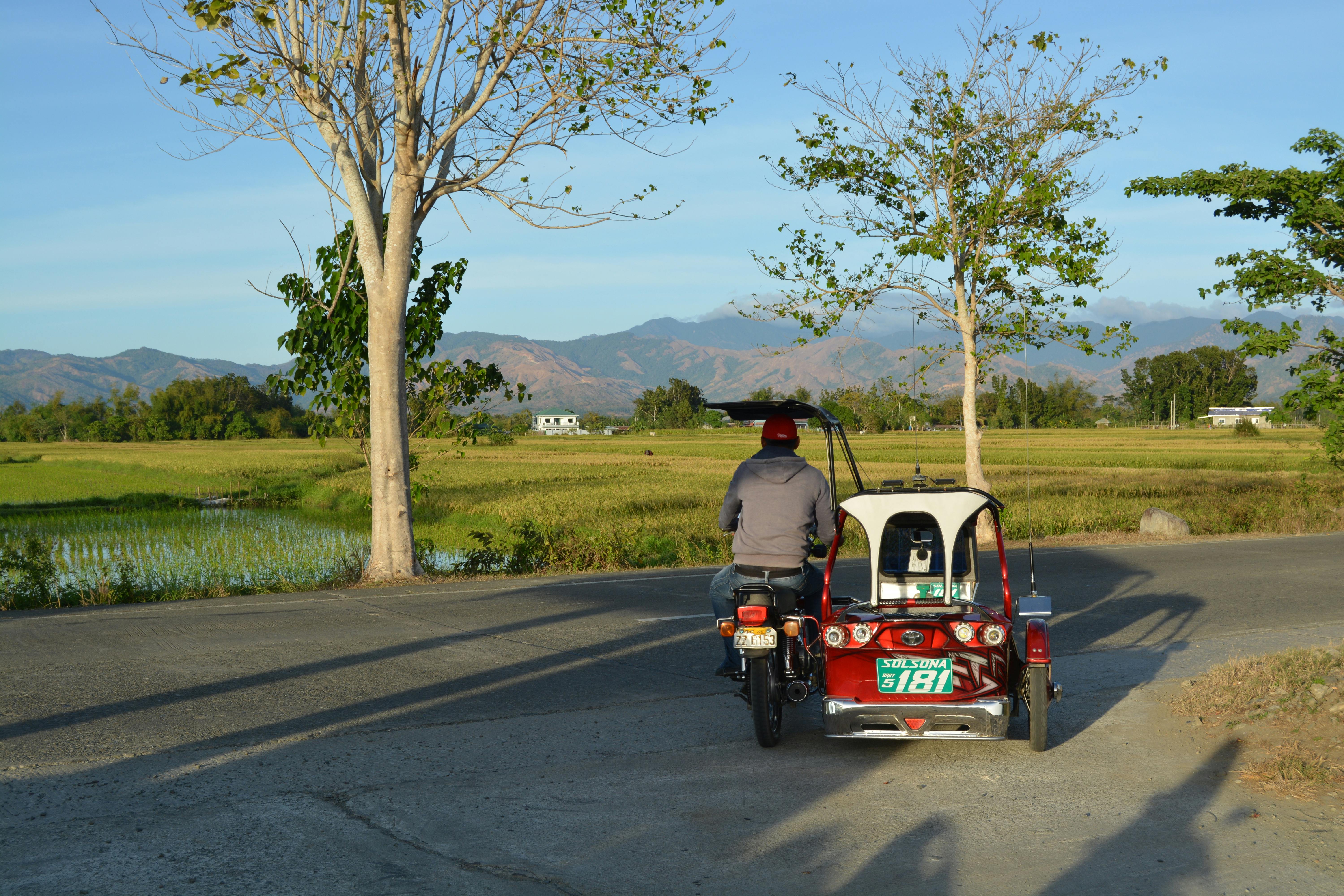 Back View of a Man Riding on a Motorcycle with Additional Seat on the ...