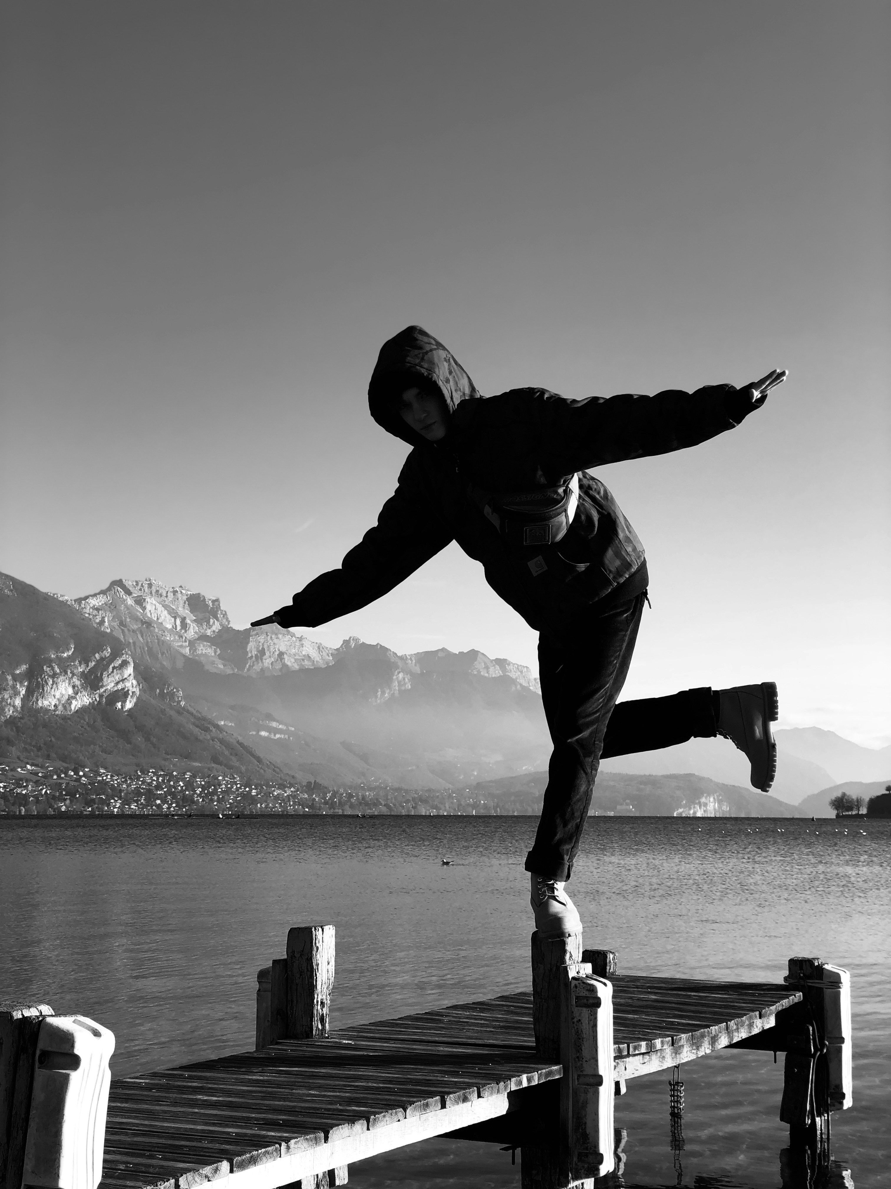 Person Balancing with Leg Raised on Wooden Boardwalk on Lakeshore ...