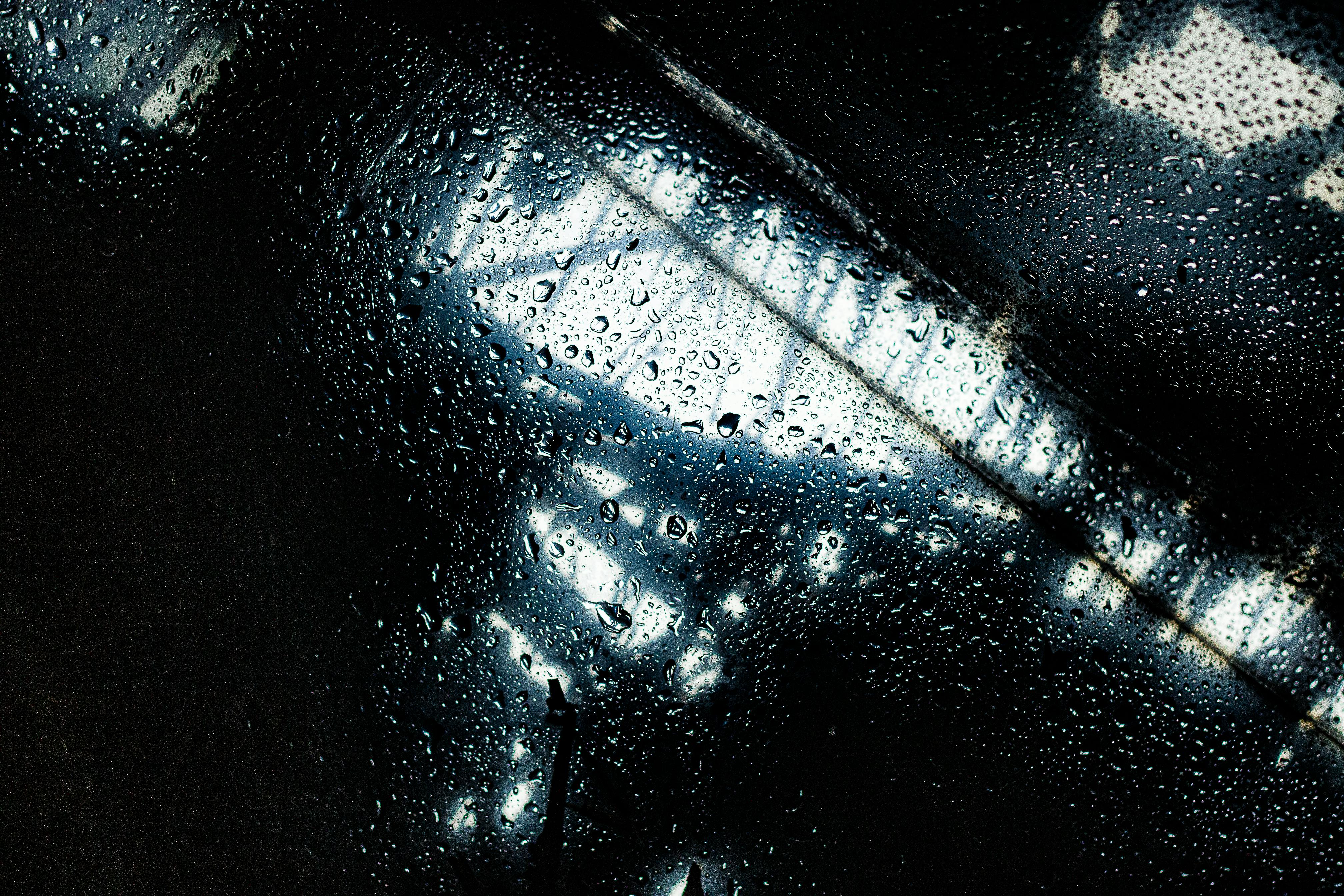 Raindrops on Dark Window Glass · Free Stock Photo
