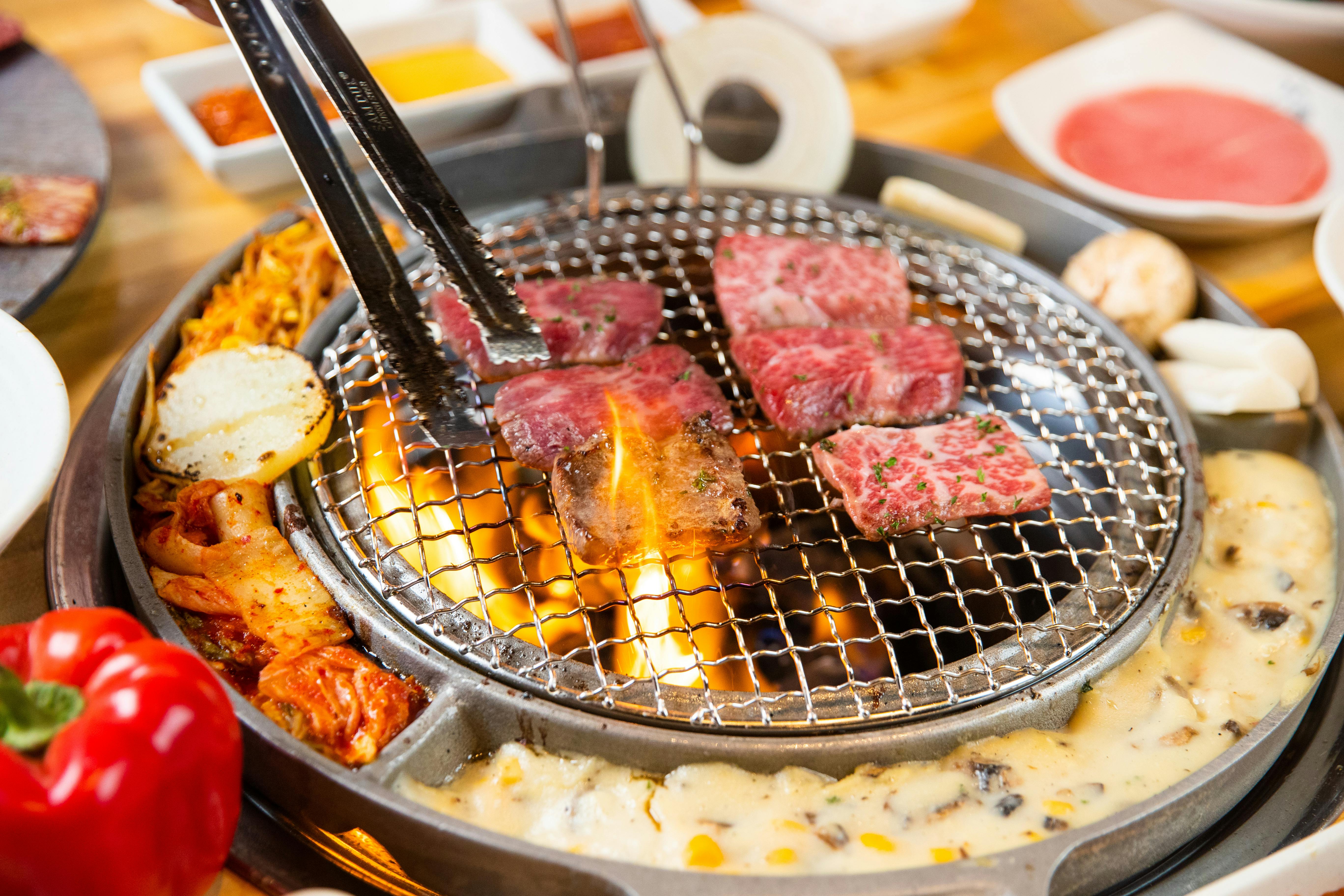 Pincers over Meat on Barbecue · Free Stock Photo