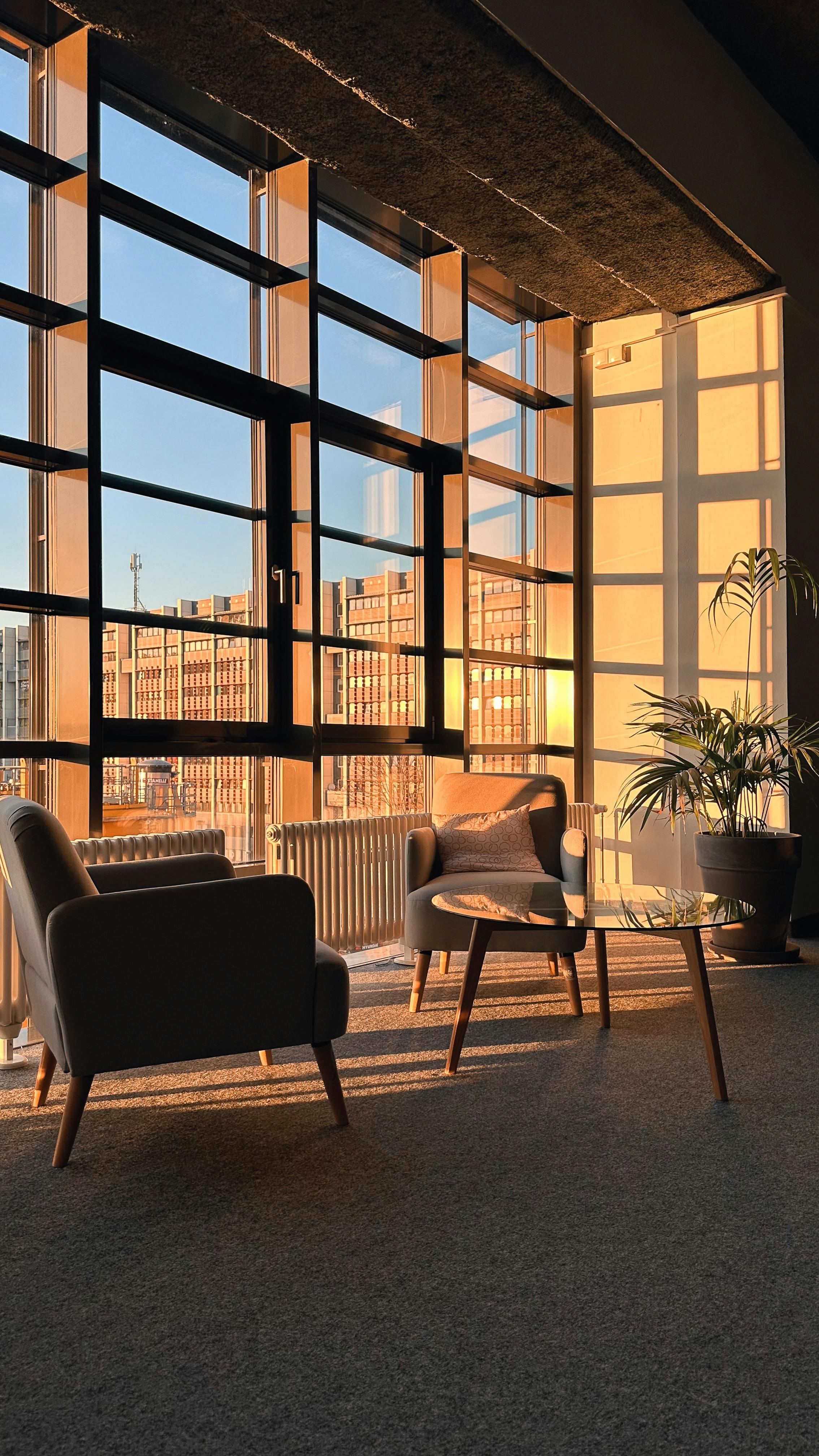 A room with a window and chairs in front of it · Free Stock Photo