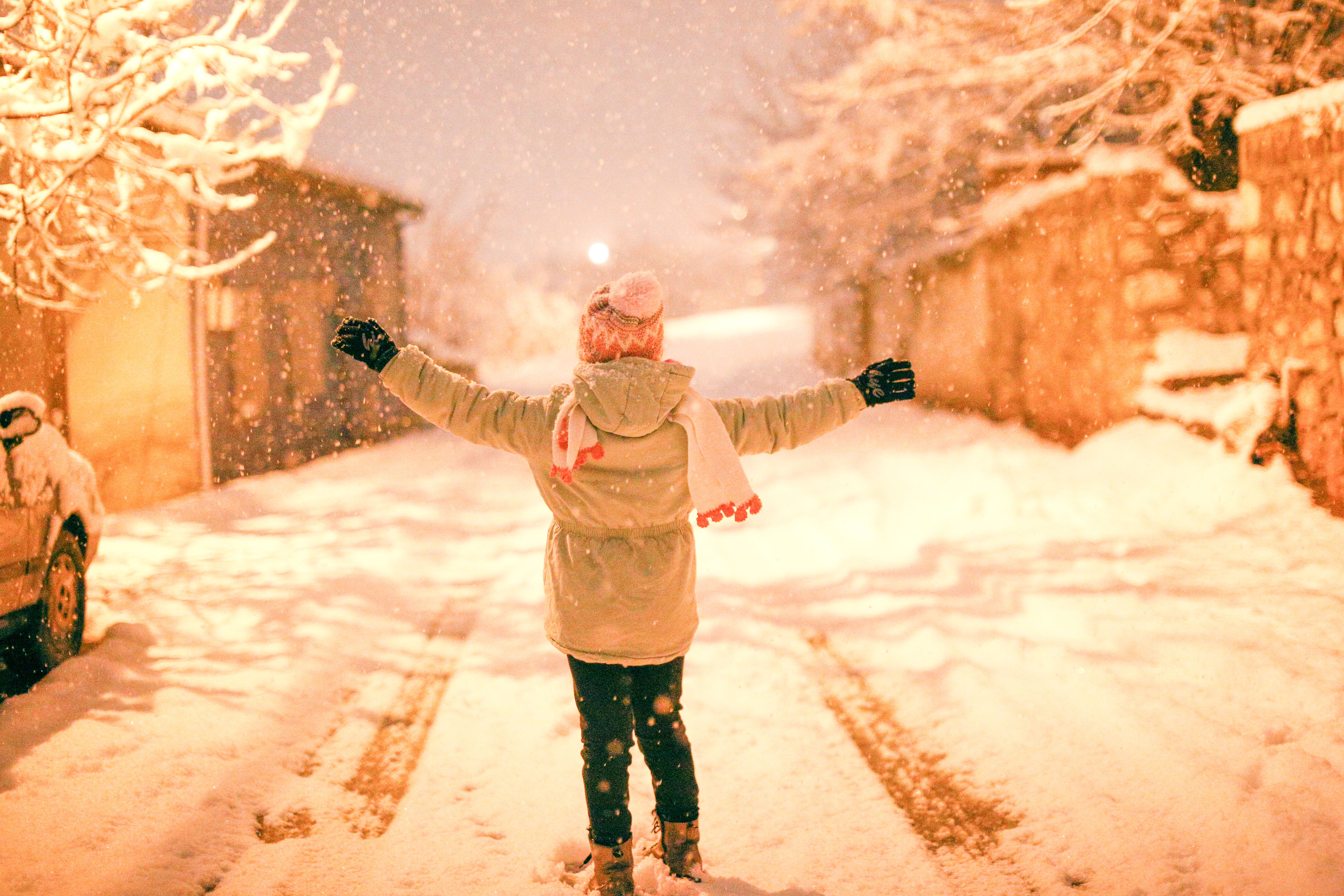 Girl on a Street Covered with Snow in the Evening · Free Stock Photo