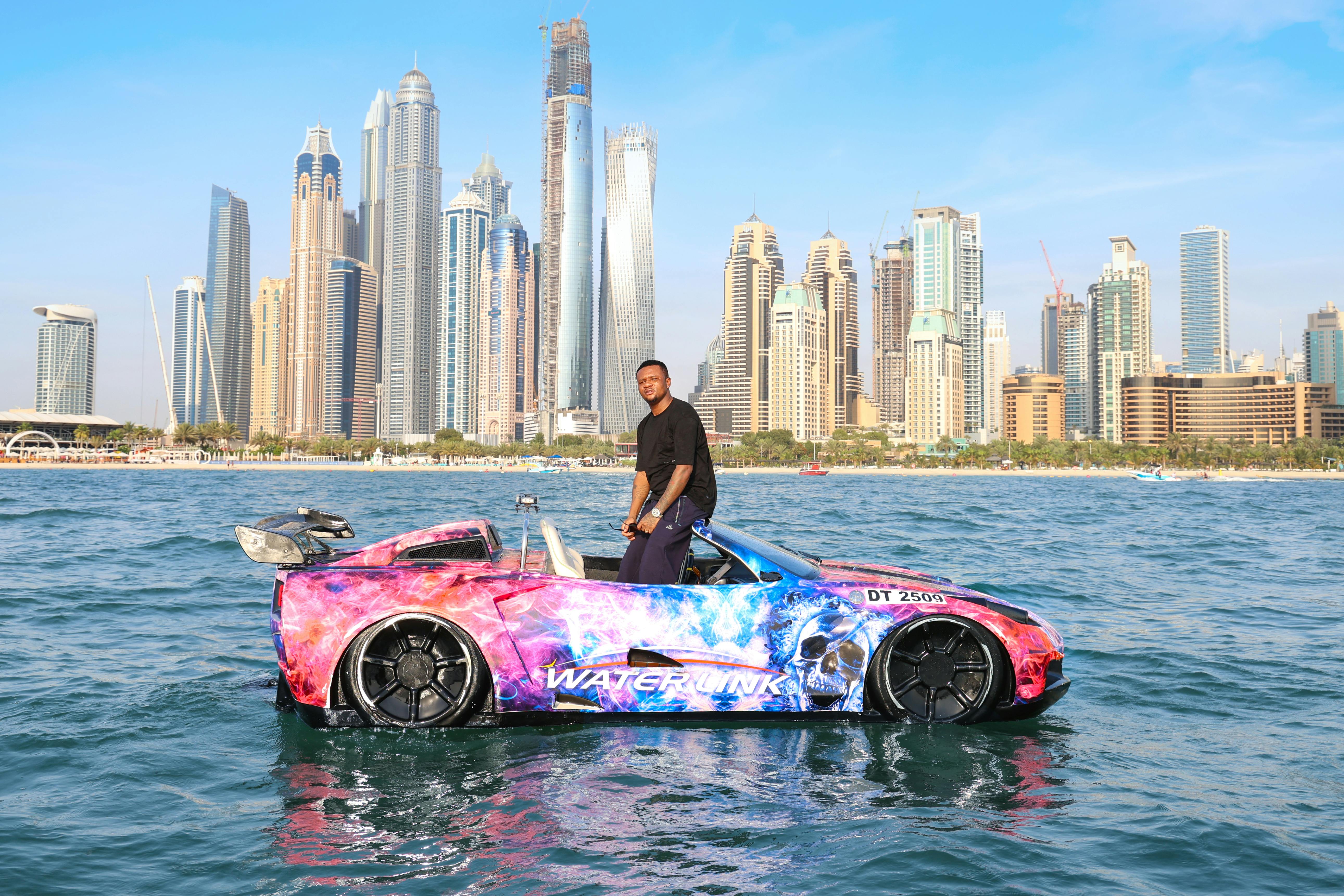 Man on a Car Shaped Boat in Port in Dubai · Free Stock Photo
