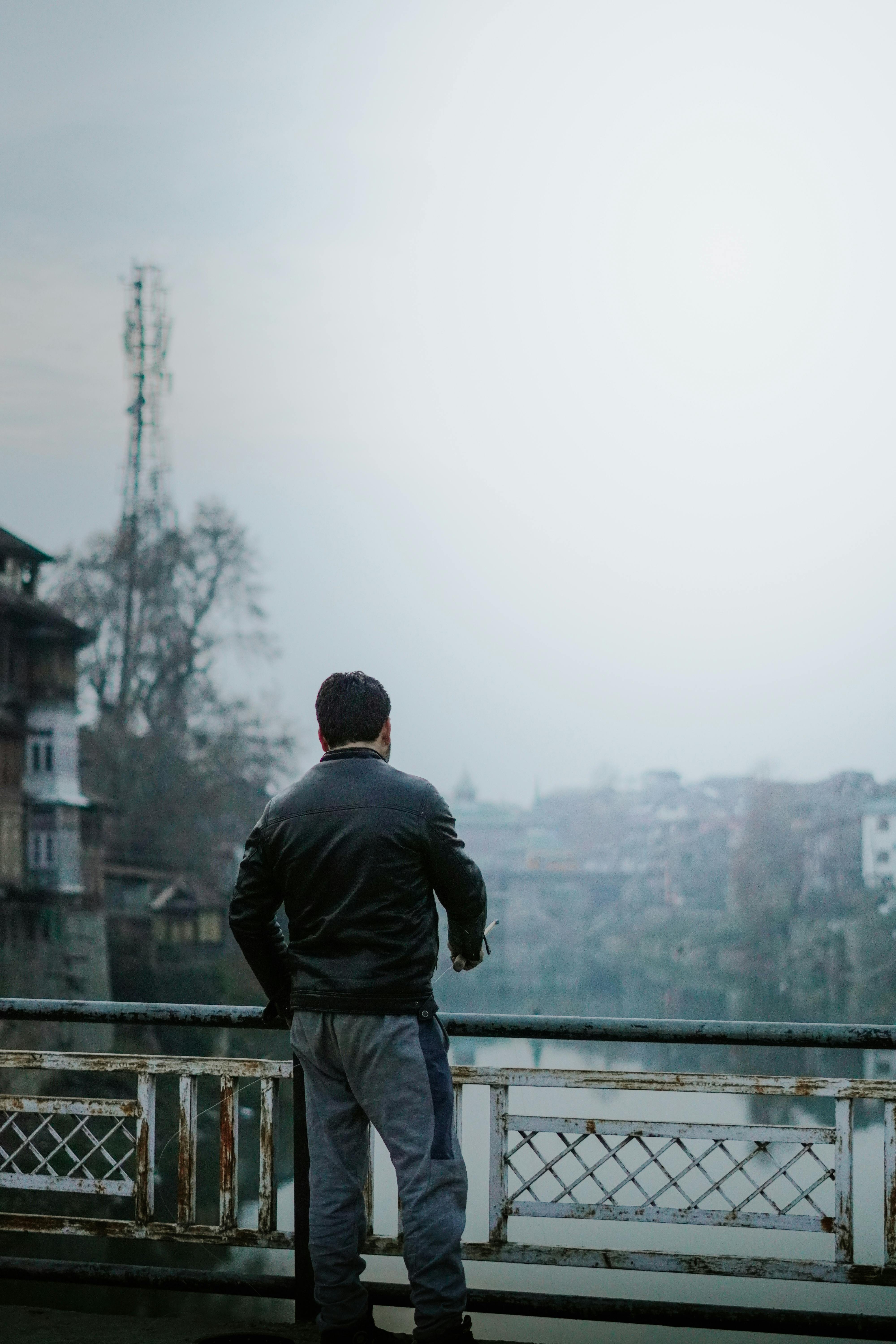 Man on Bridge over River in City · Free Stock Photo