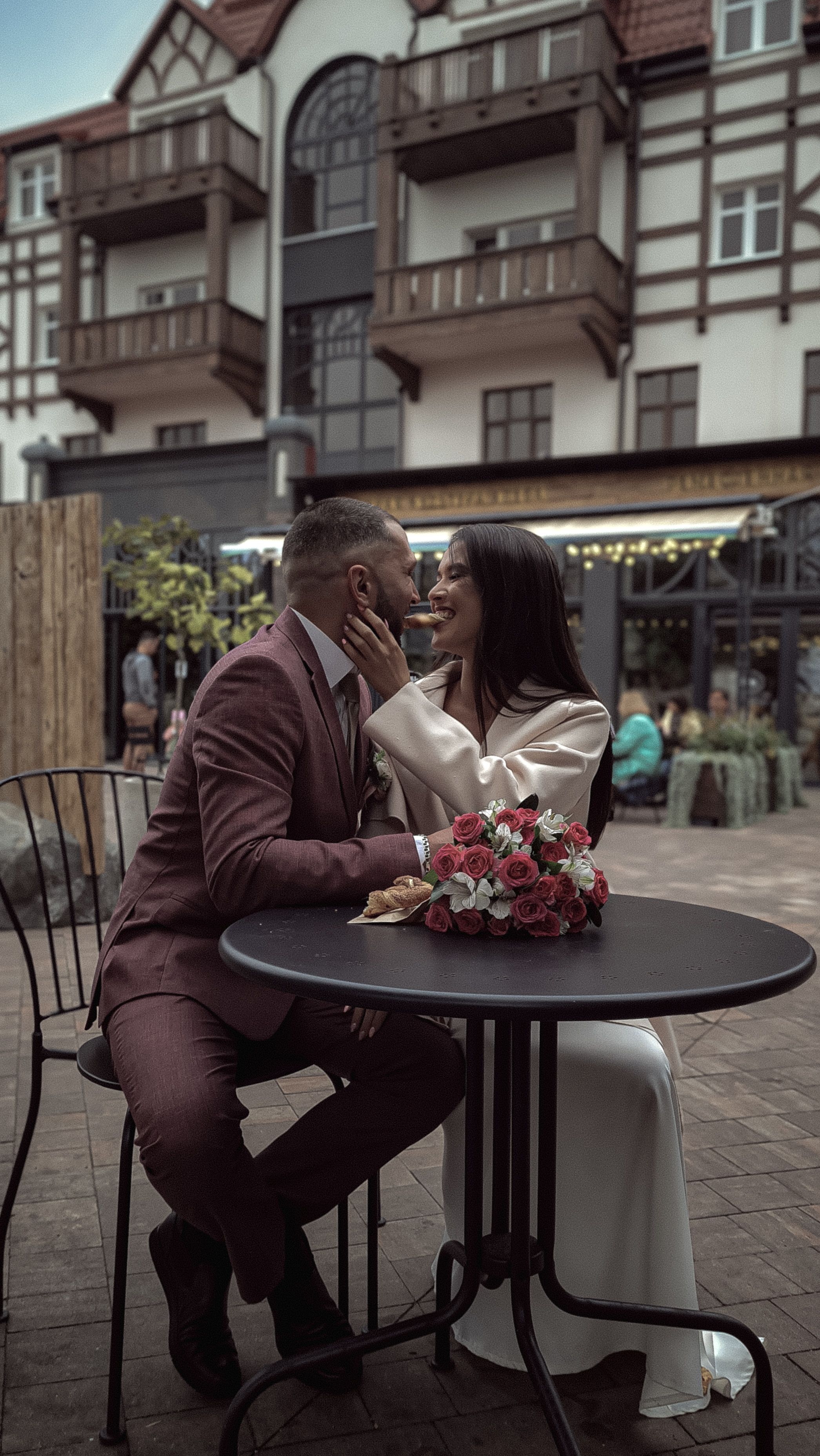 Elegant Couple Sitting at a Table on a Cafe Patio · Free Stock Photo