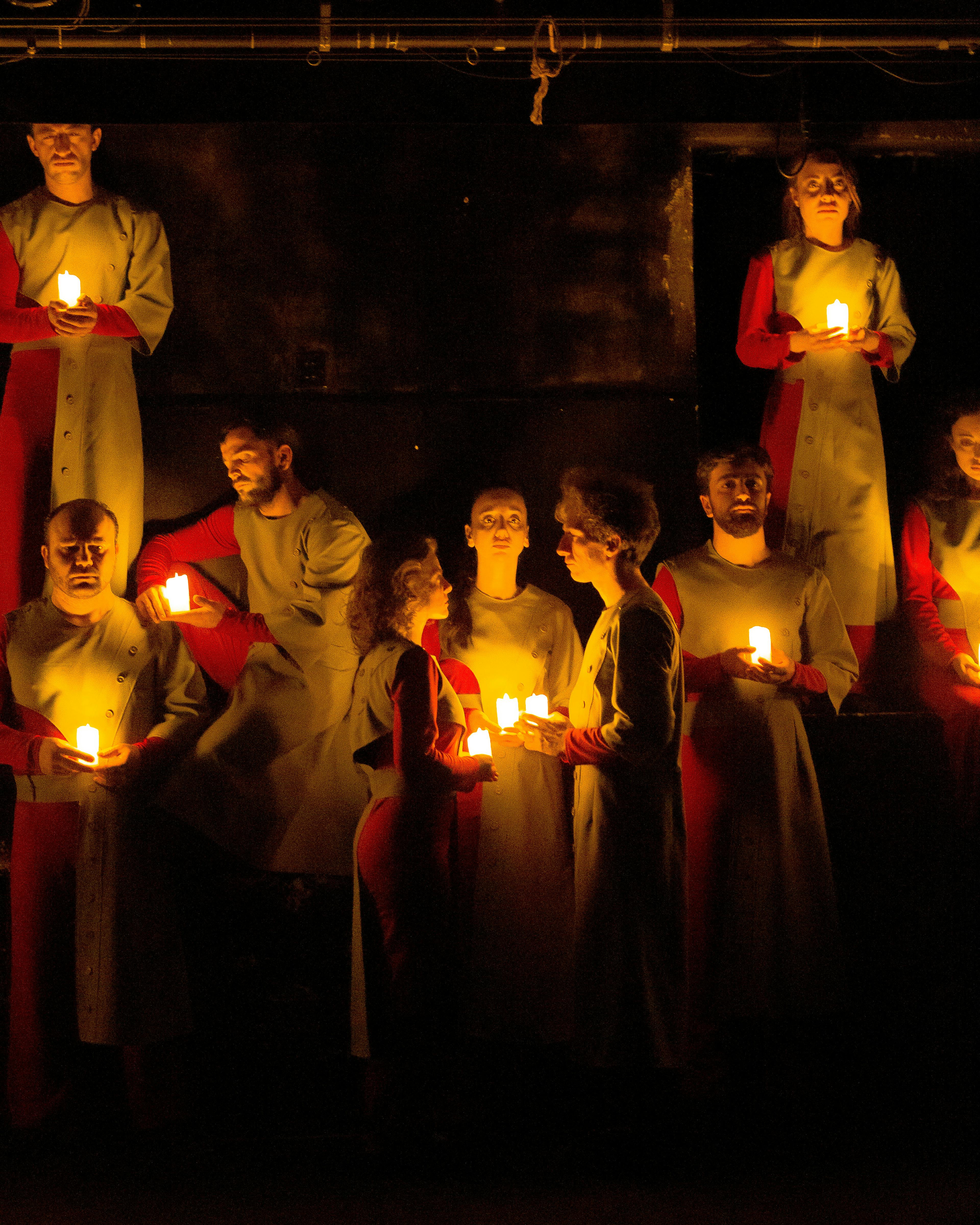 People in Costumes Holding Candles during a Performance · Free Stock Photo