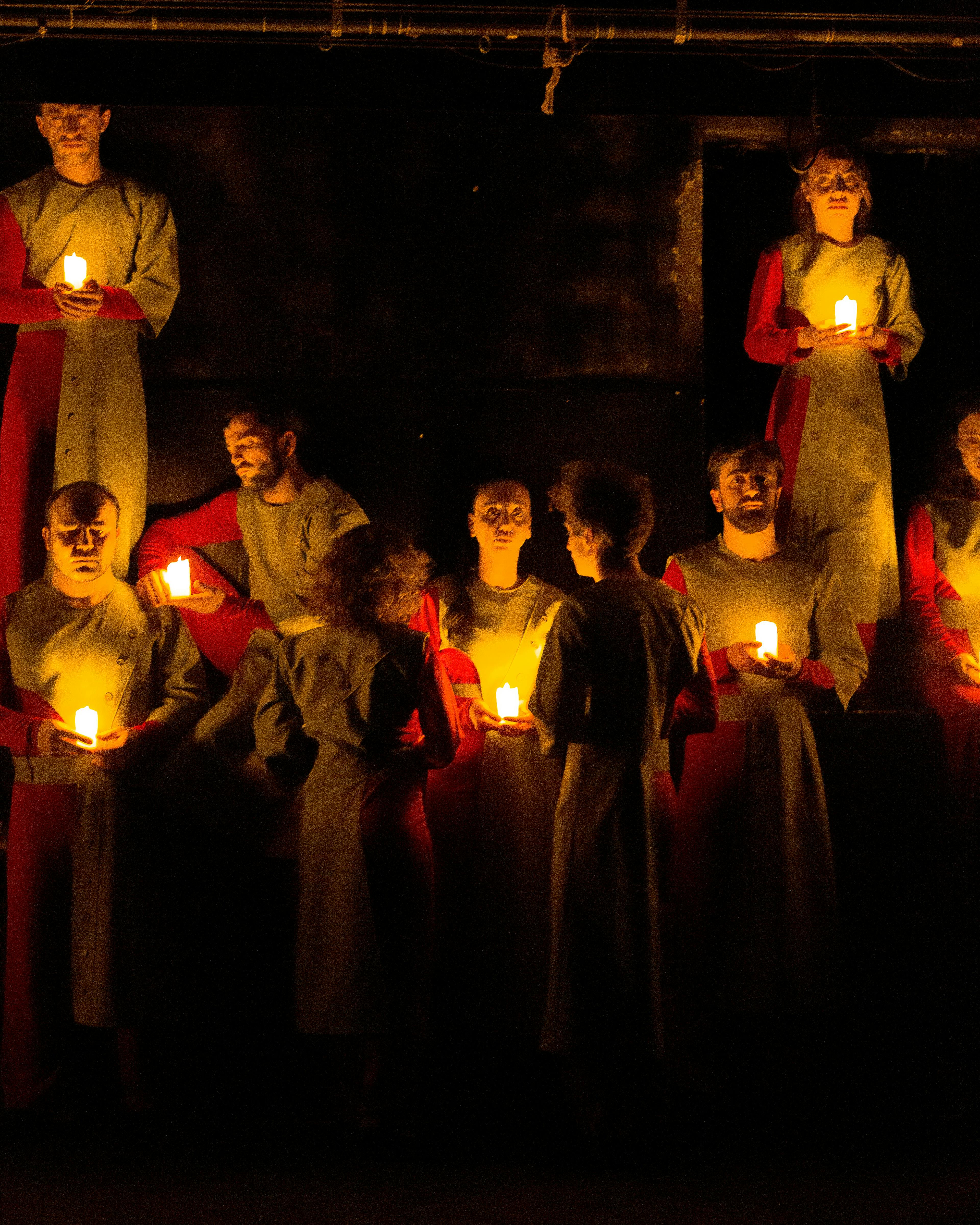People in Costumes Holding Candles during a Performance · Free Stock Photo