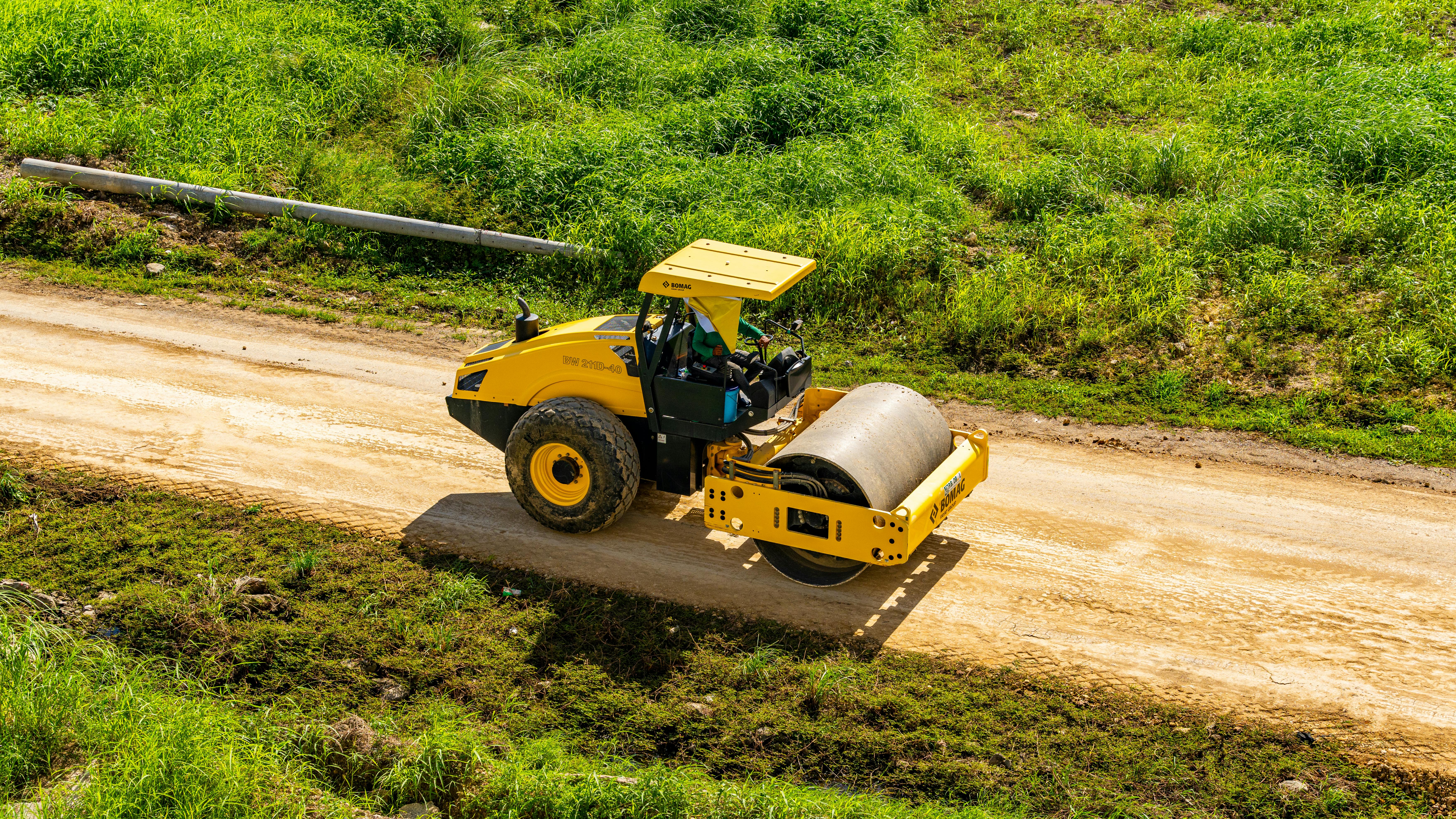 Man Driving Roller on Dirt Road · Free Stock Photo