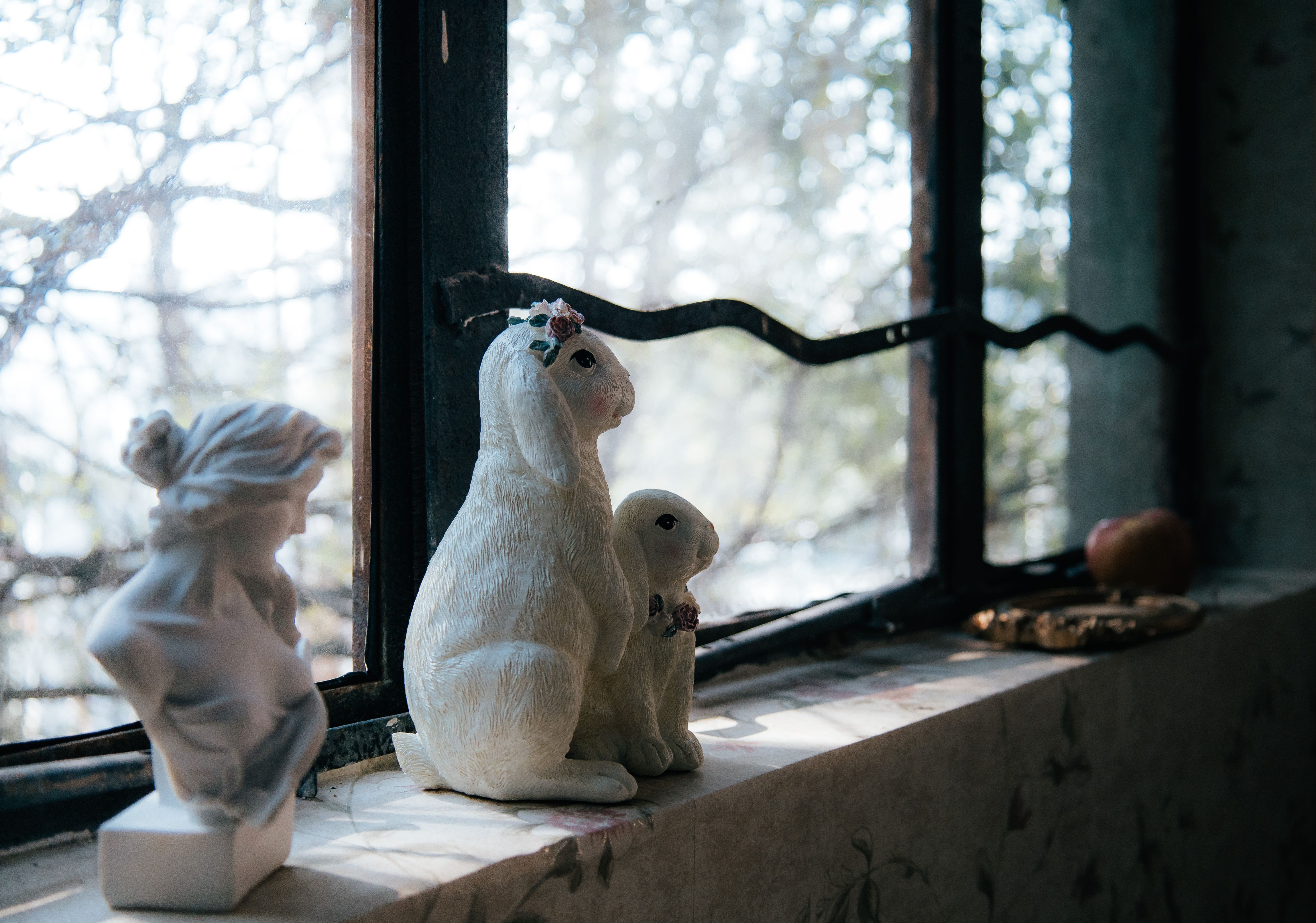 Figurines of Animals and Bust on Windowsill · Free Stock Photo