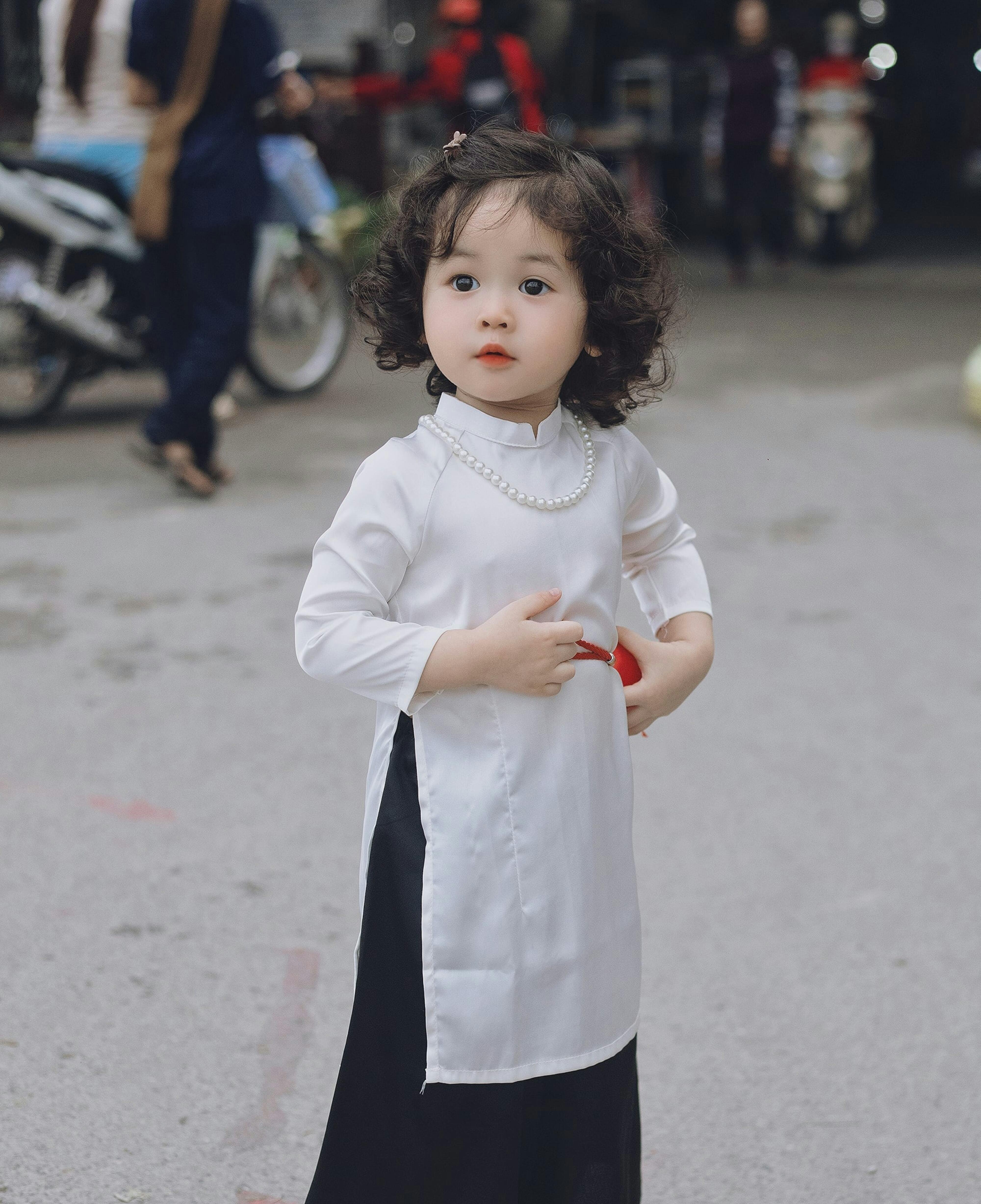 Girl in Mandarin Gown is Standing · Free Stock Photo
