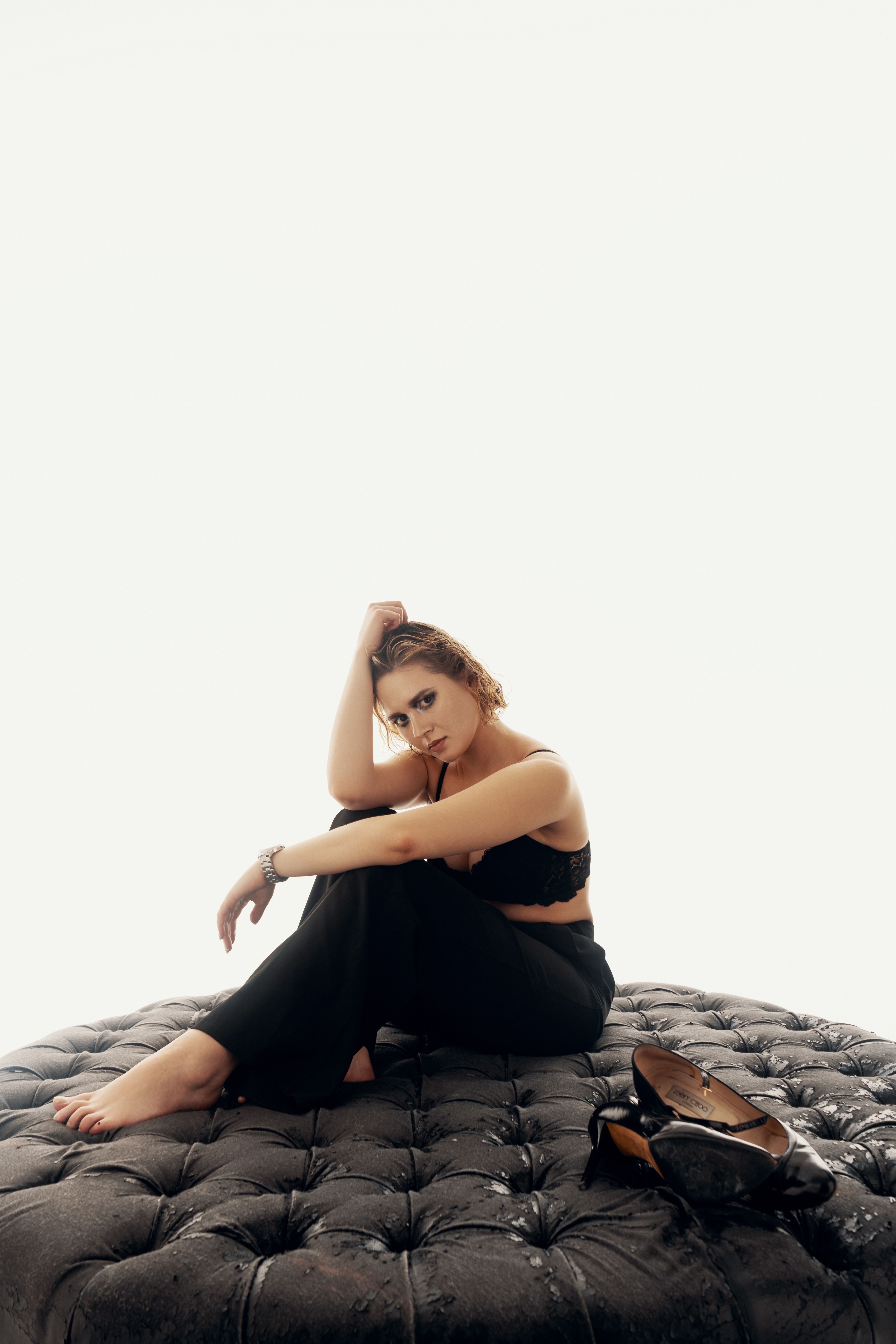 Woman in Bra Sitting on White Background · Free Stock Photo