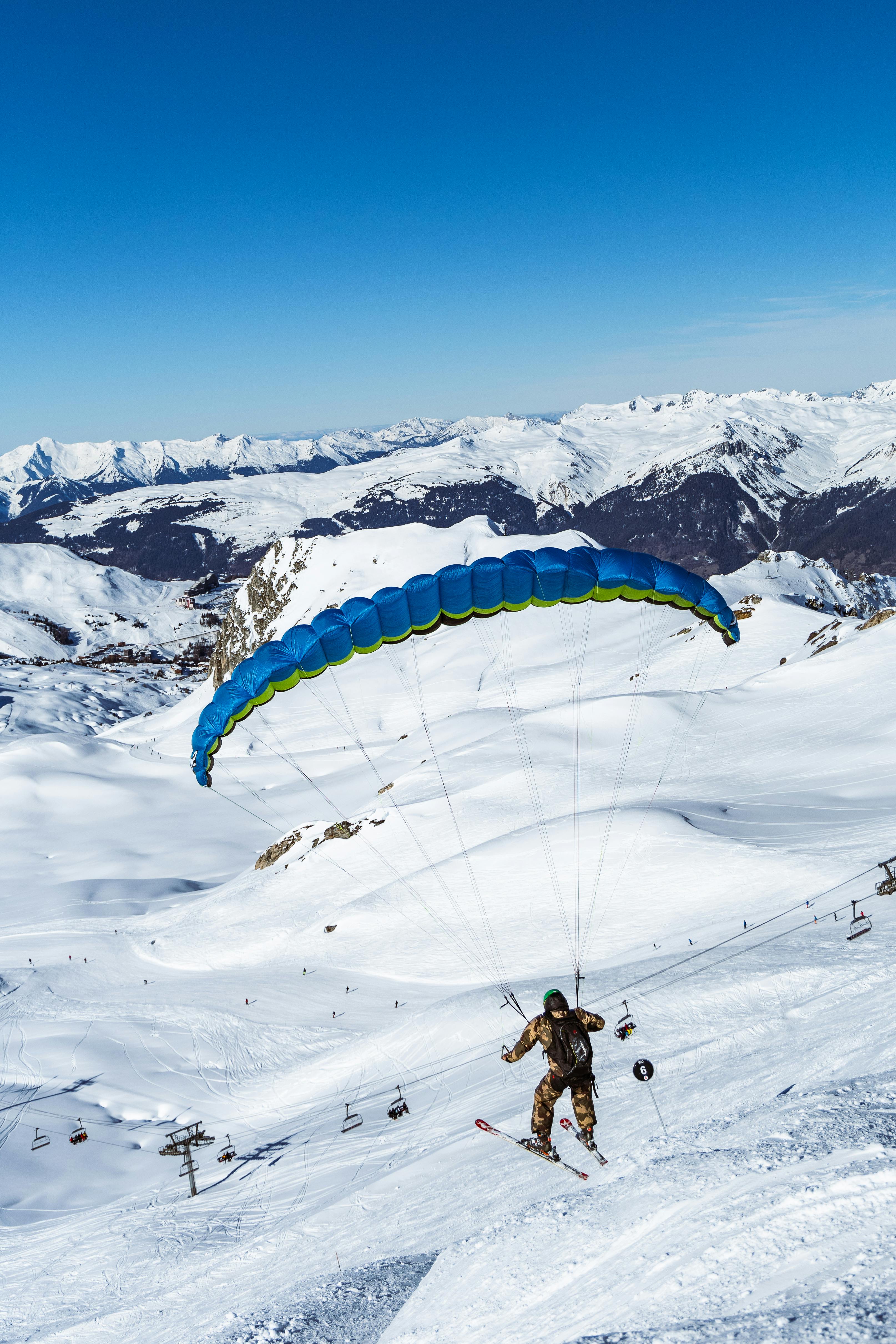 Man Jumping on Skis with Parachute · Free Stock Photo