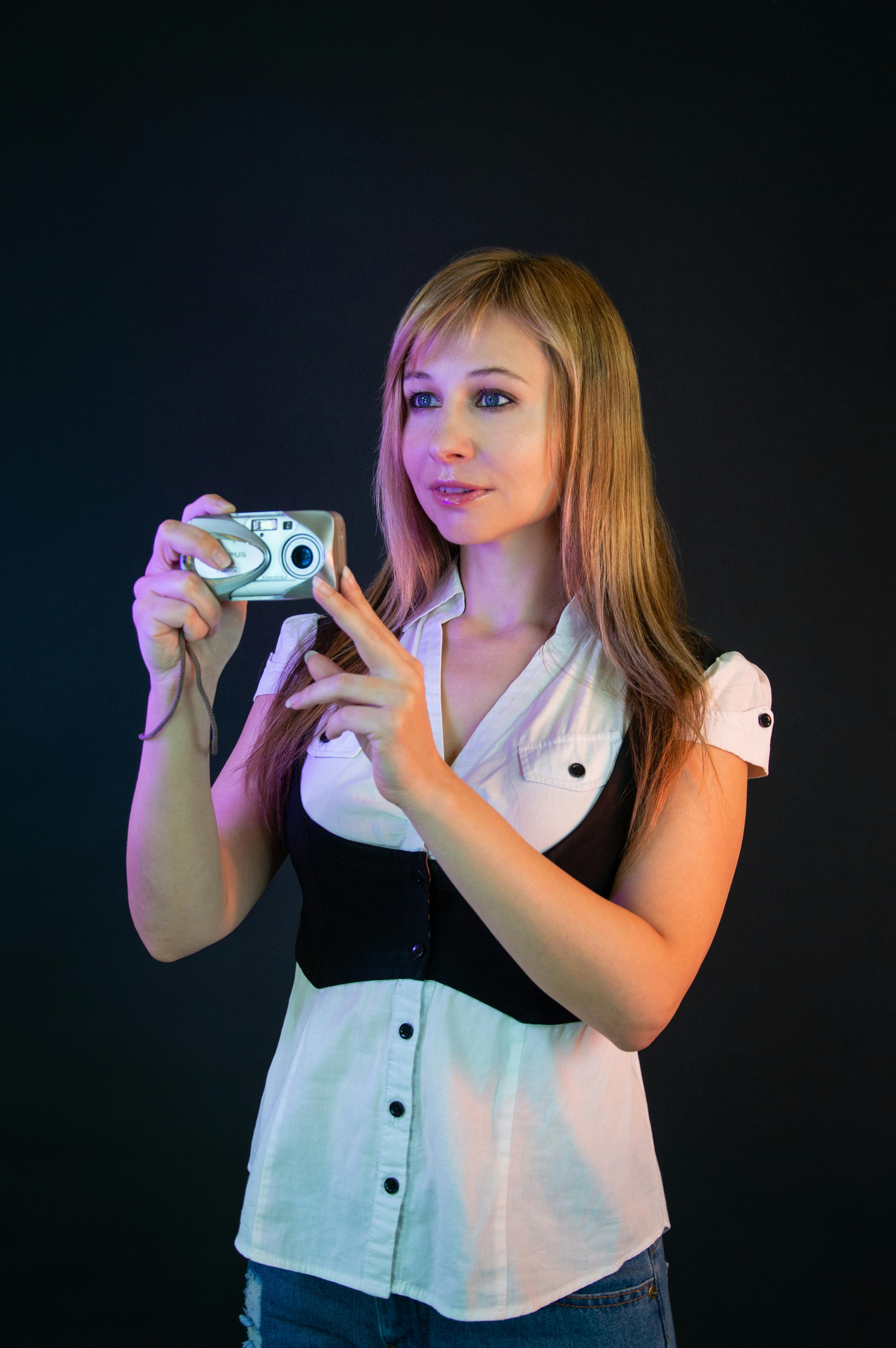 Young Woman Holding a Film Camera · Free Stock Photo