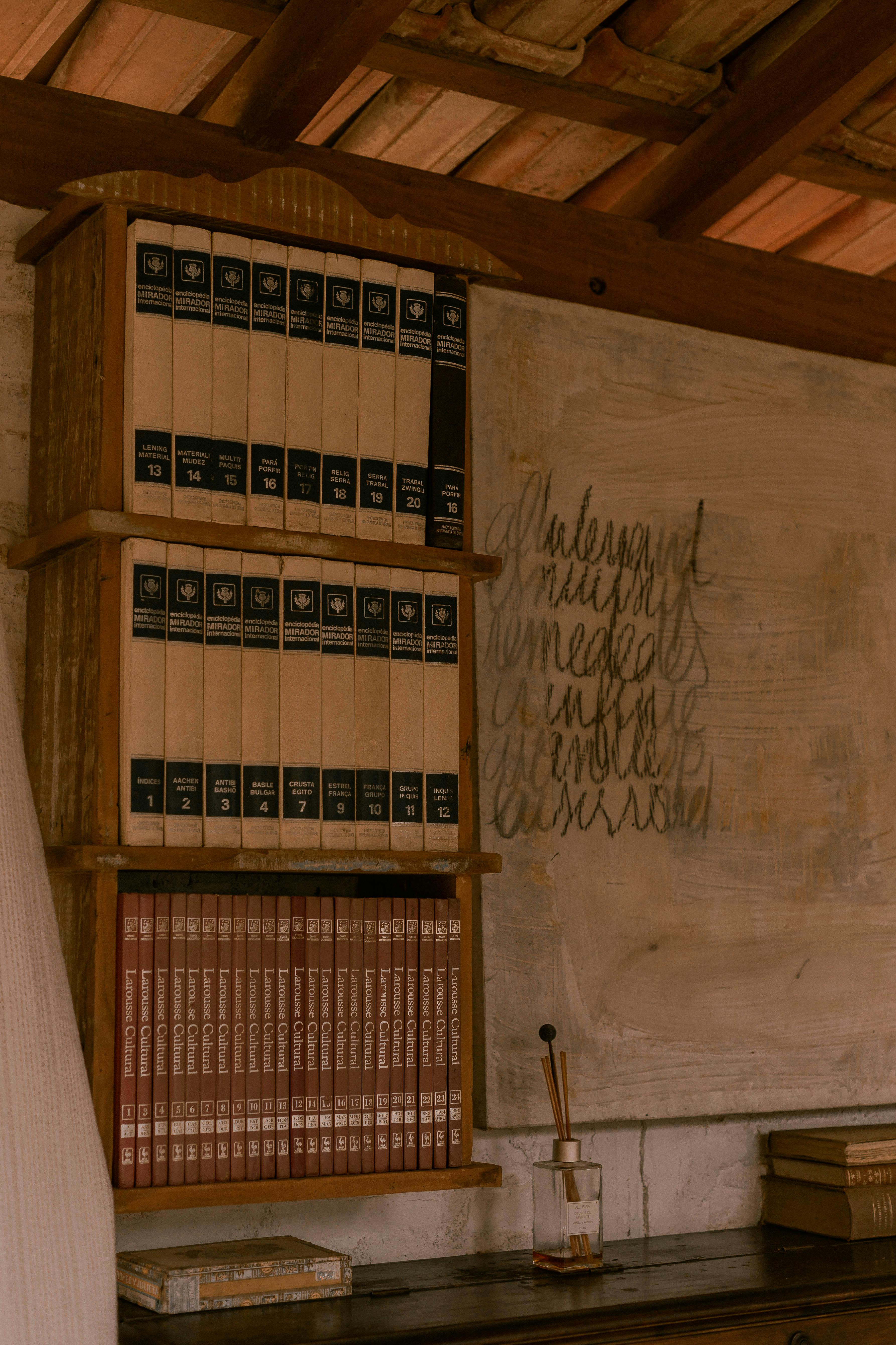 Old Books on Shelves over a Desk · Free Stock Photo