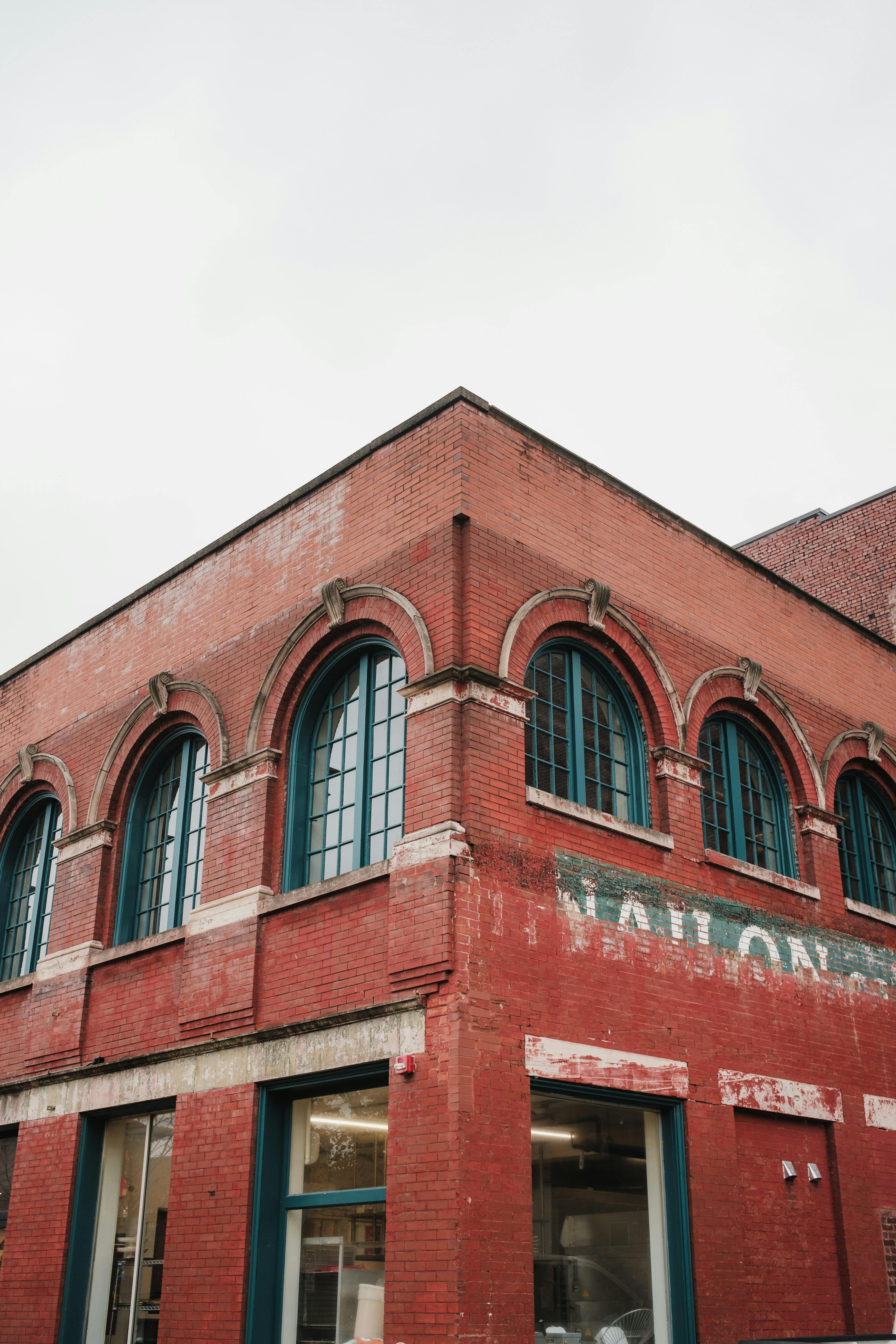 Urban Red Brick Building with Arched Windows · Free Stock Photo