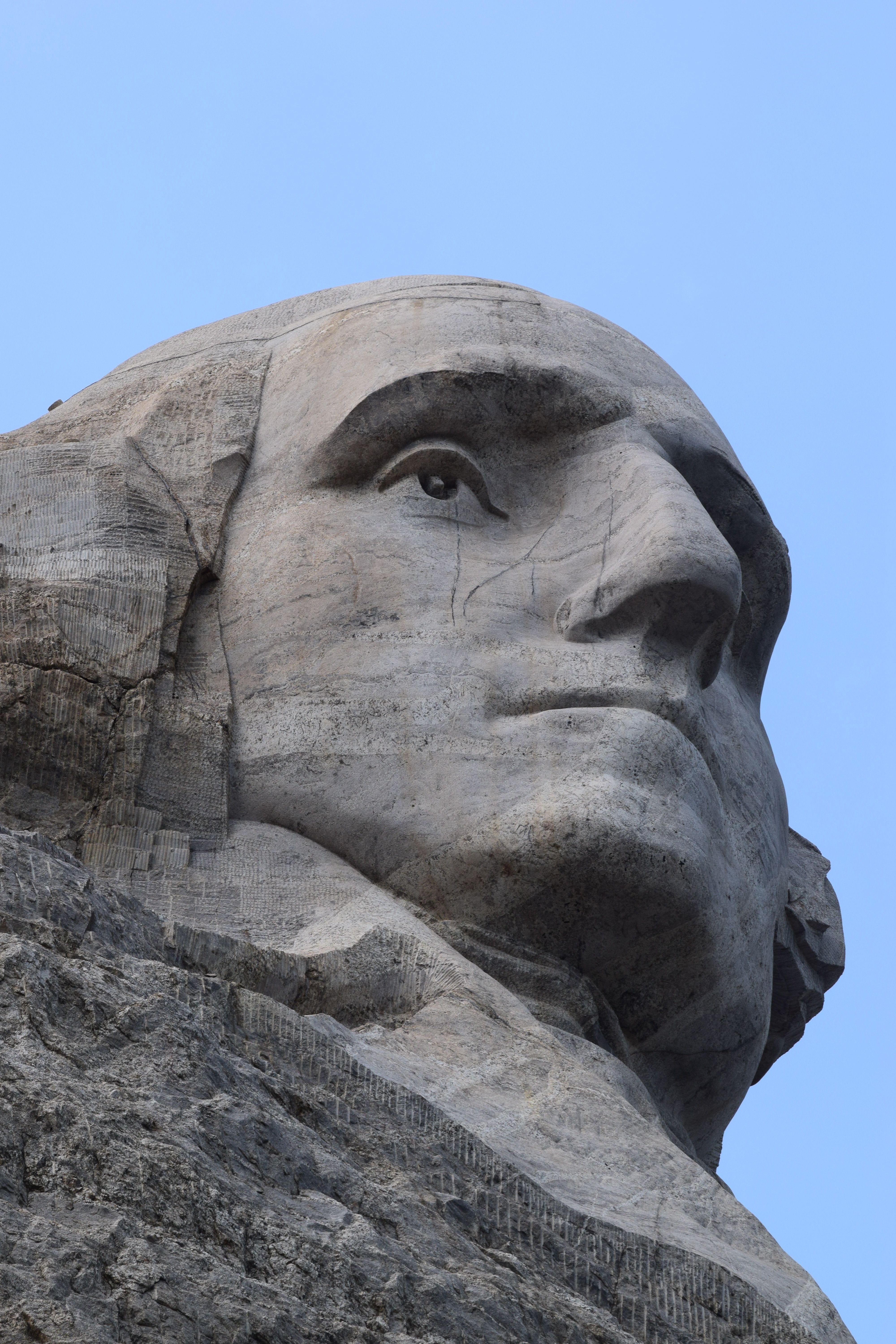 Grayscale Photo of Mans Face Concrete Statue · Free Stock Photo
