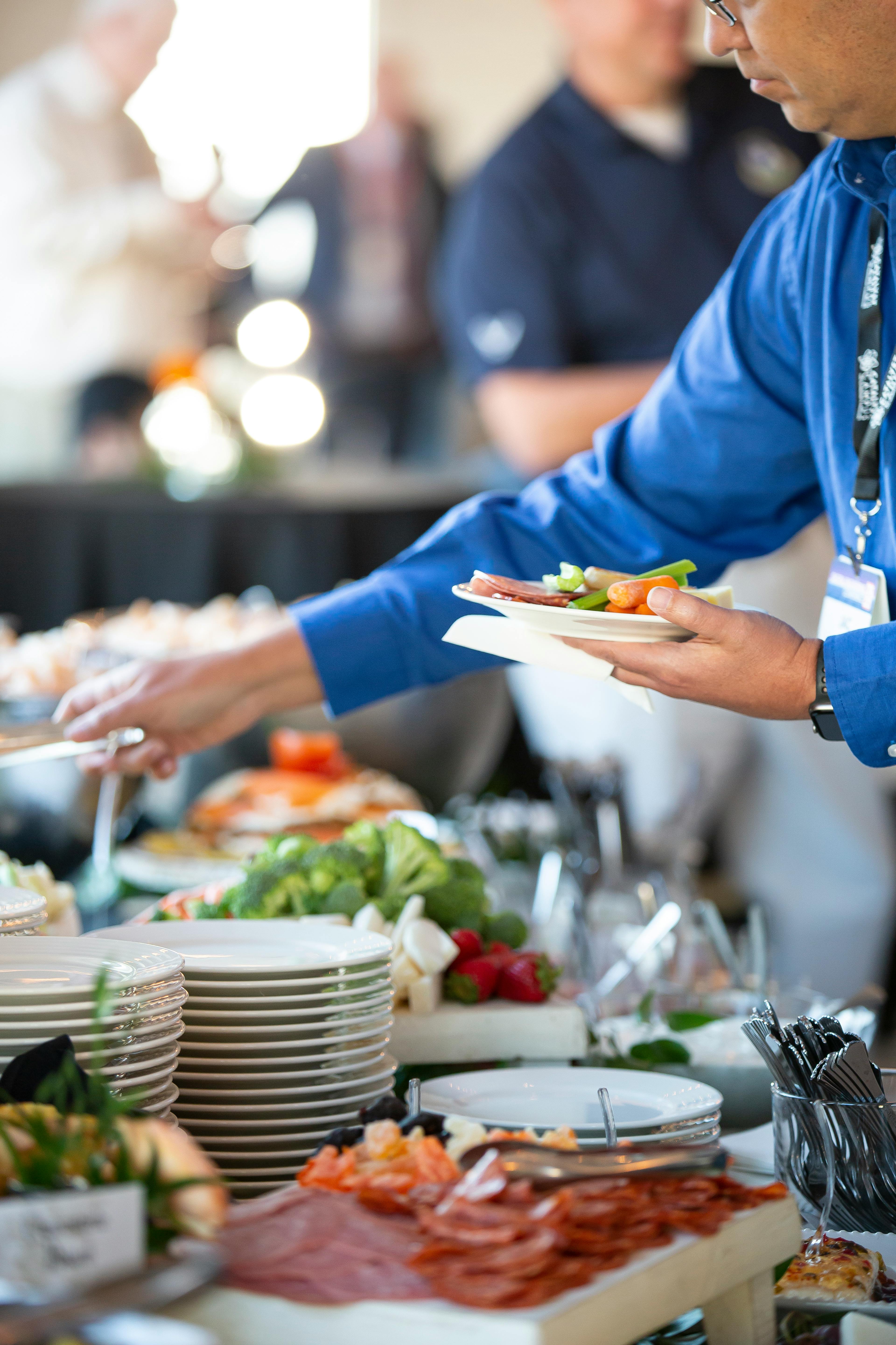 Close-up of a Man Putting Food on His Plate · Free Stock Photo