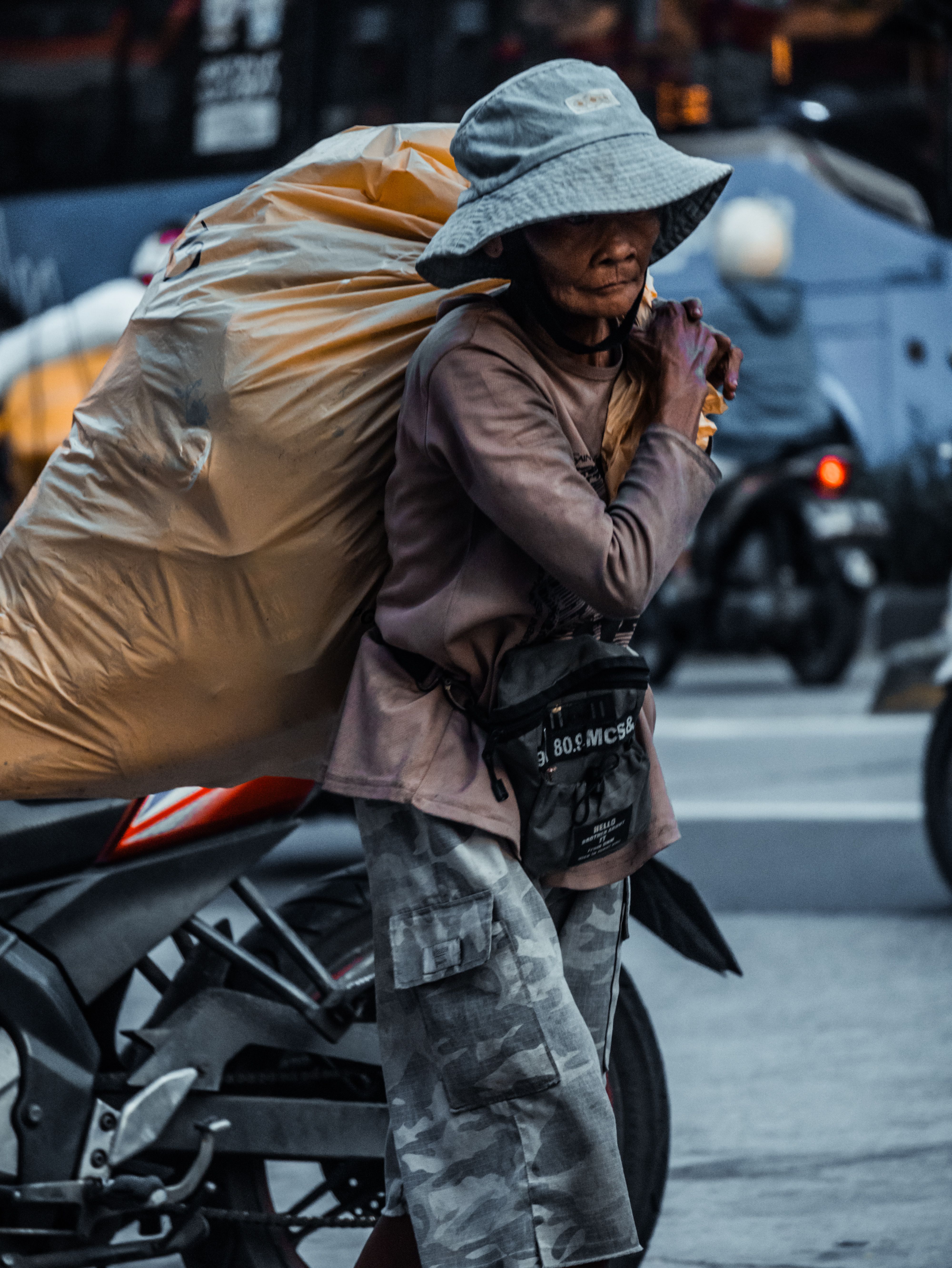 Elderly Man Carrying a Big Trash Bag · Free Stock Photo