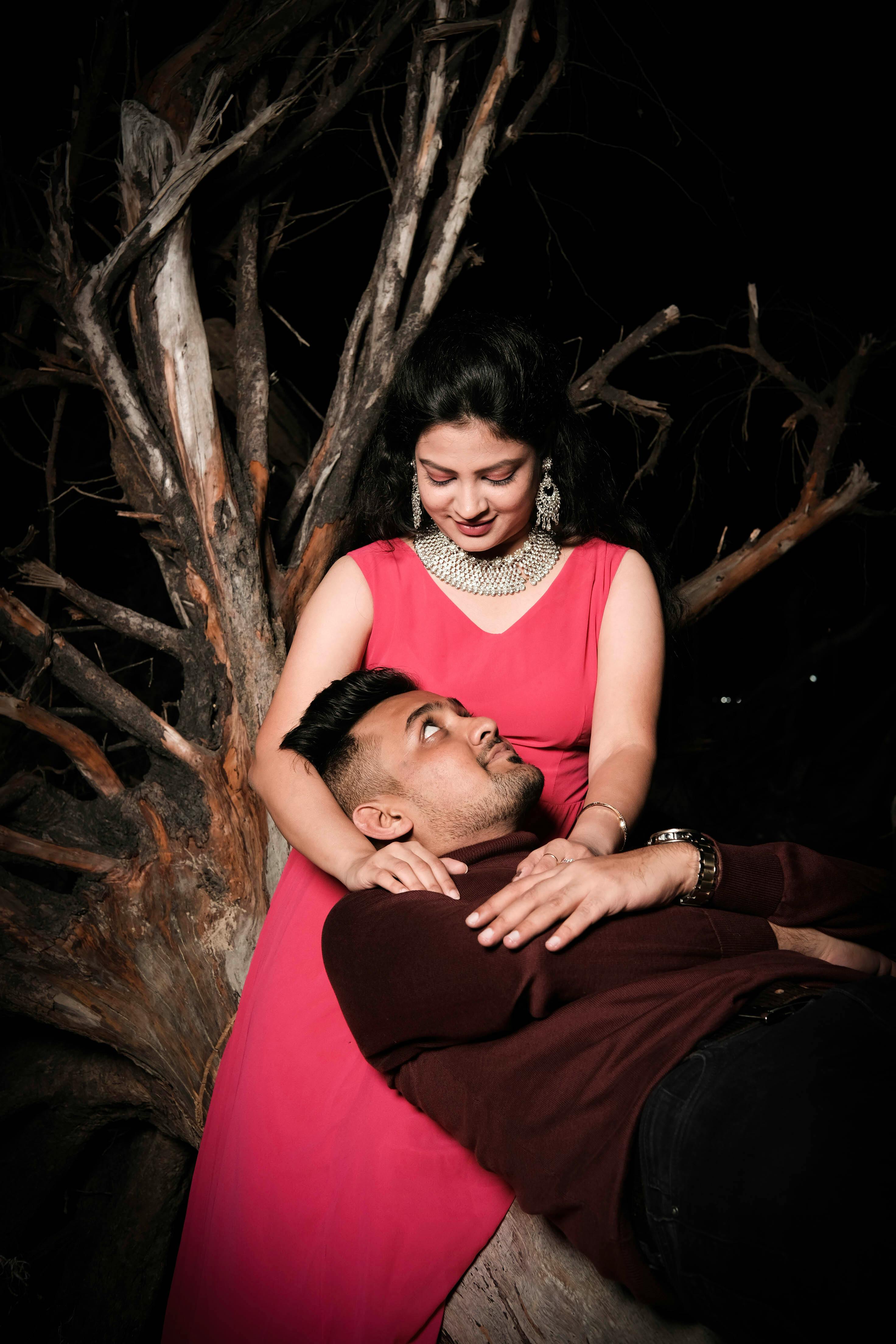 A Couple Sitting on a Tree Log at Night · Free Stock Photo