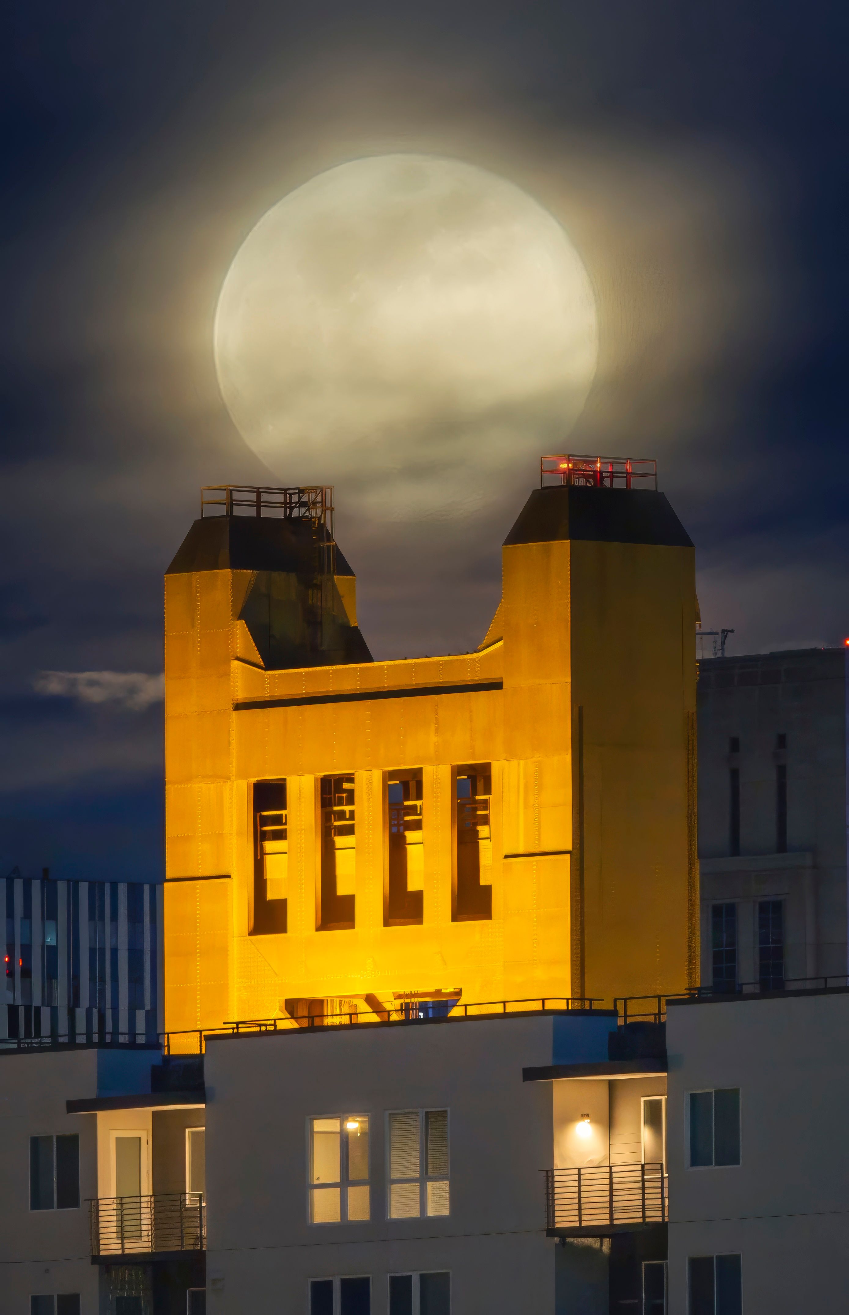 Full Moon behind Cloud over Yellow Building · Free Stock Photo