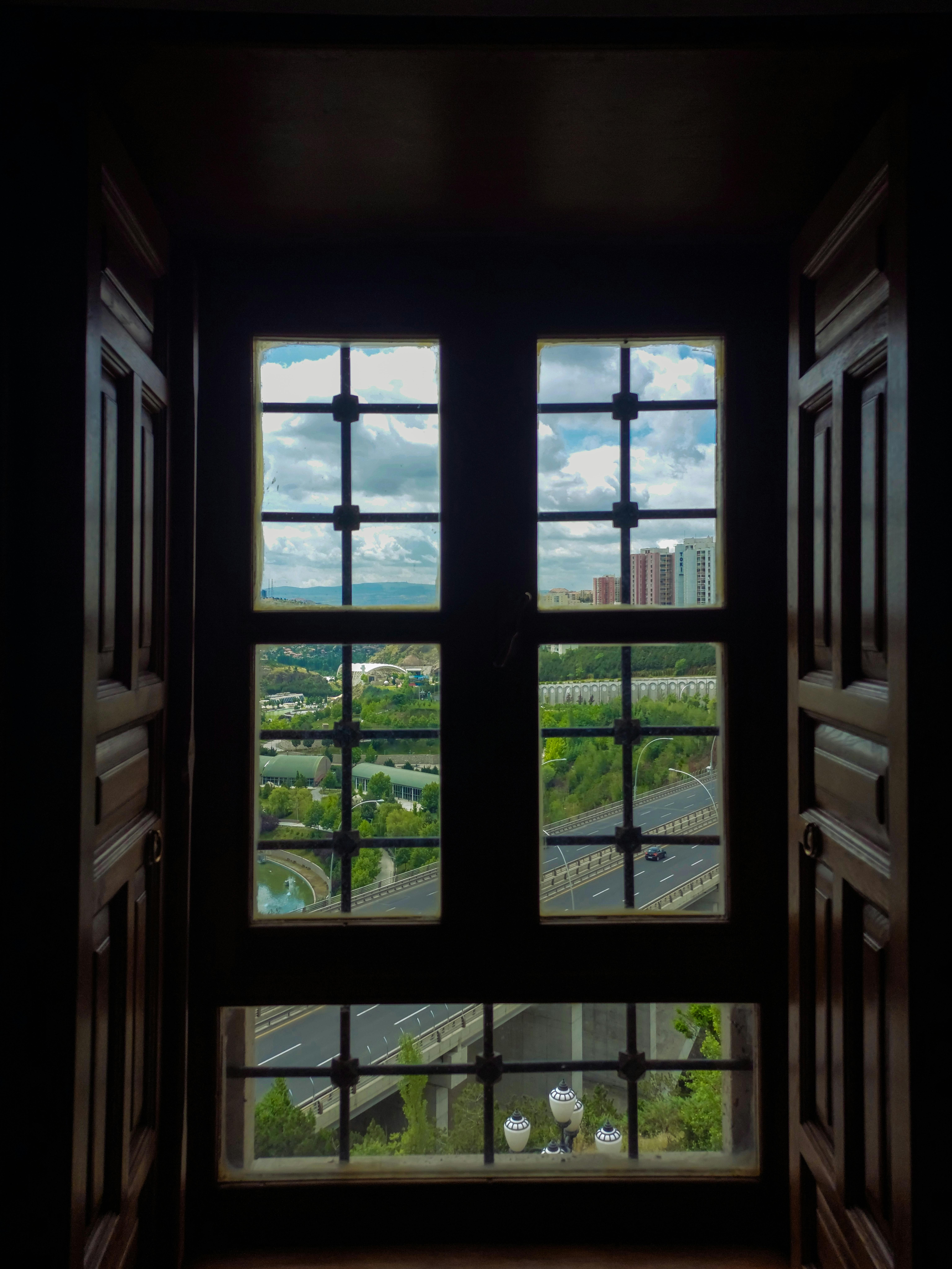 City Through Old Wooden Barred Window · Free Stock Photo