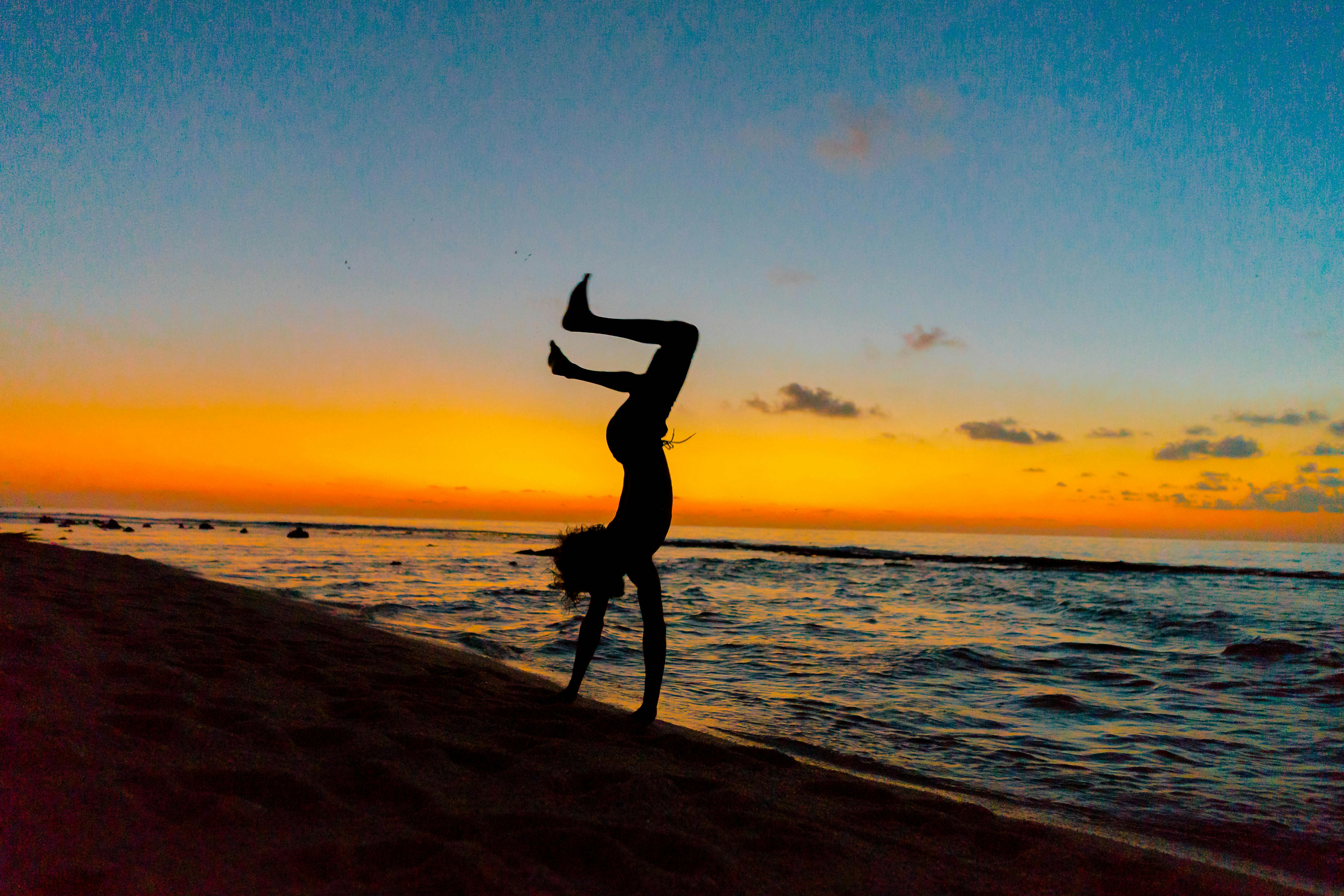 Person in Handstand on Sea Shore at Sunset · Free Stock Photo