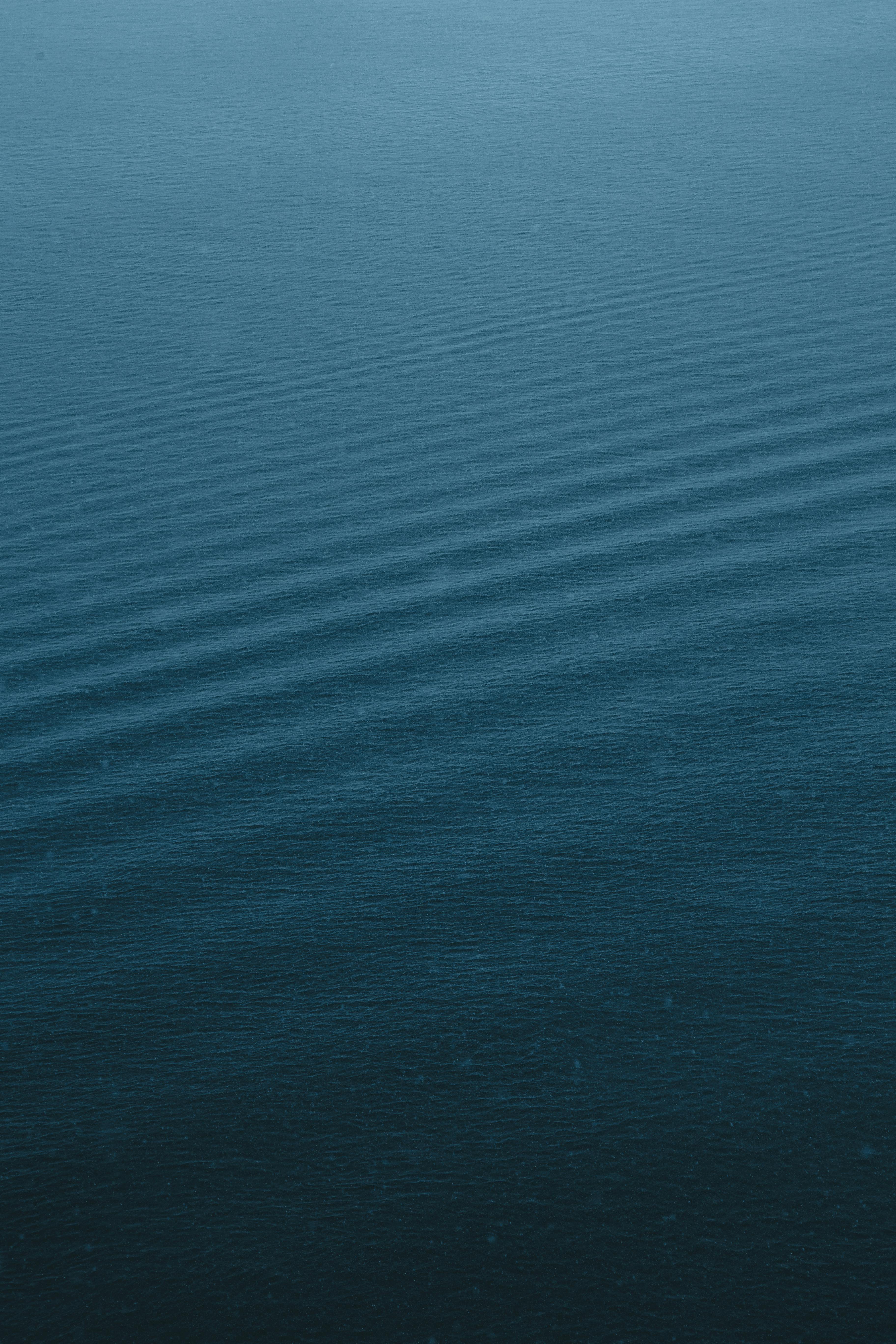 A blue ocean with ripples in the water · Free Stock Photo