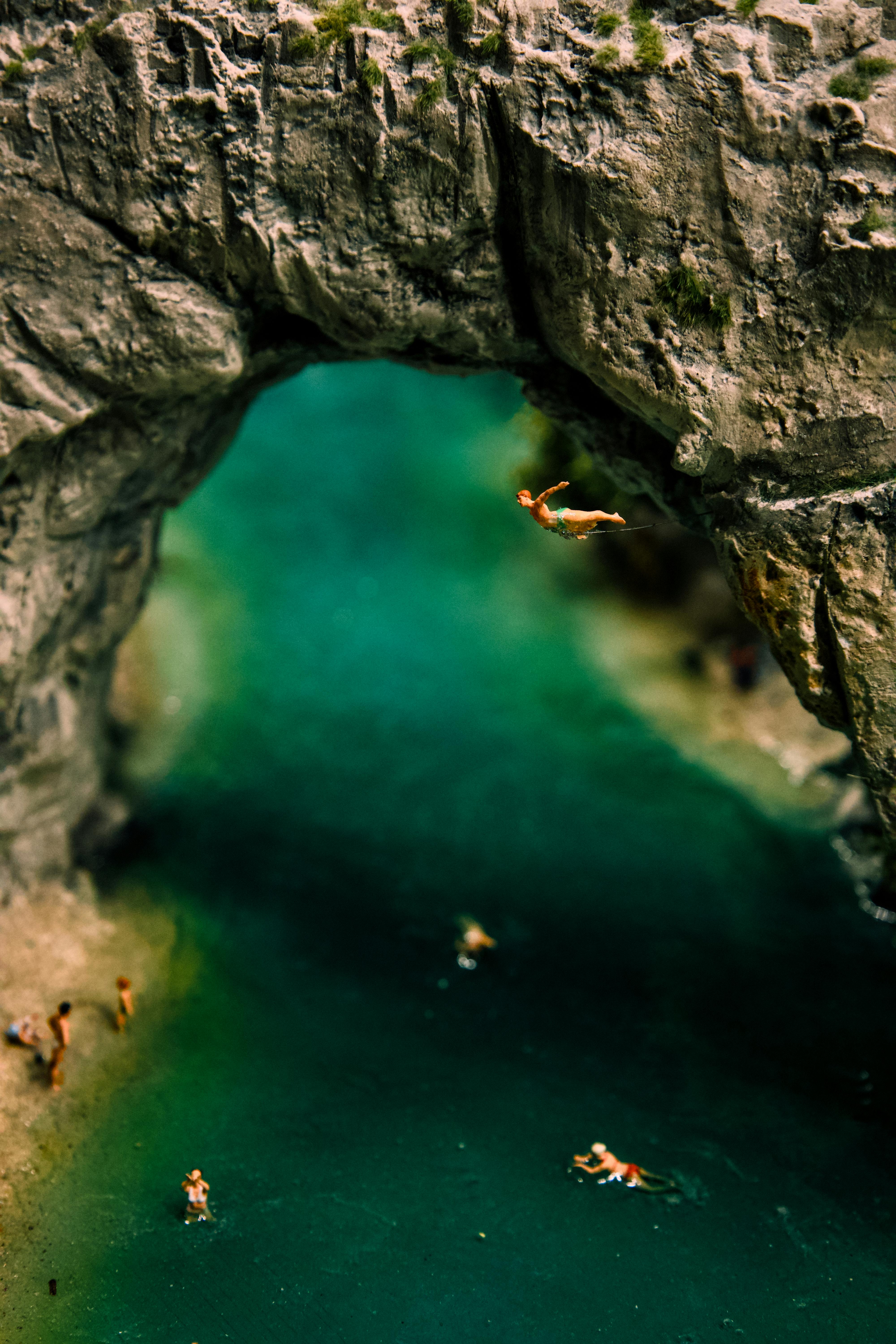Person Sitting on the Edge of Troll Tongue Rock Formation · Free Stock ...