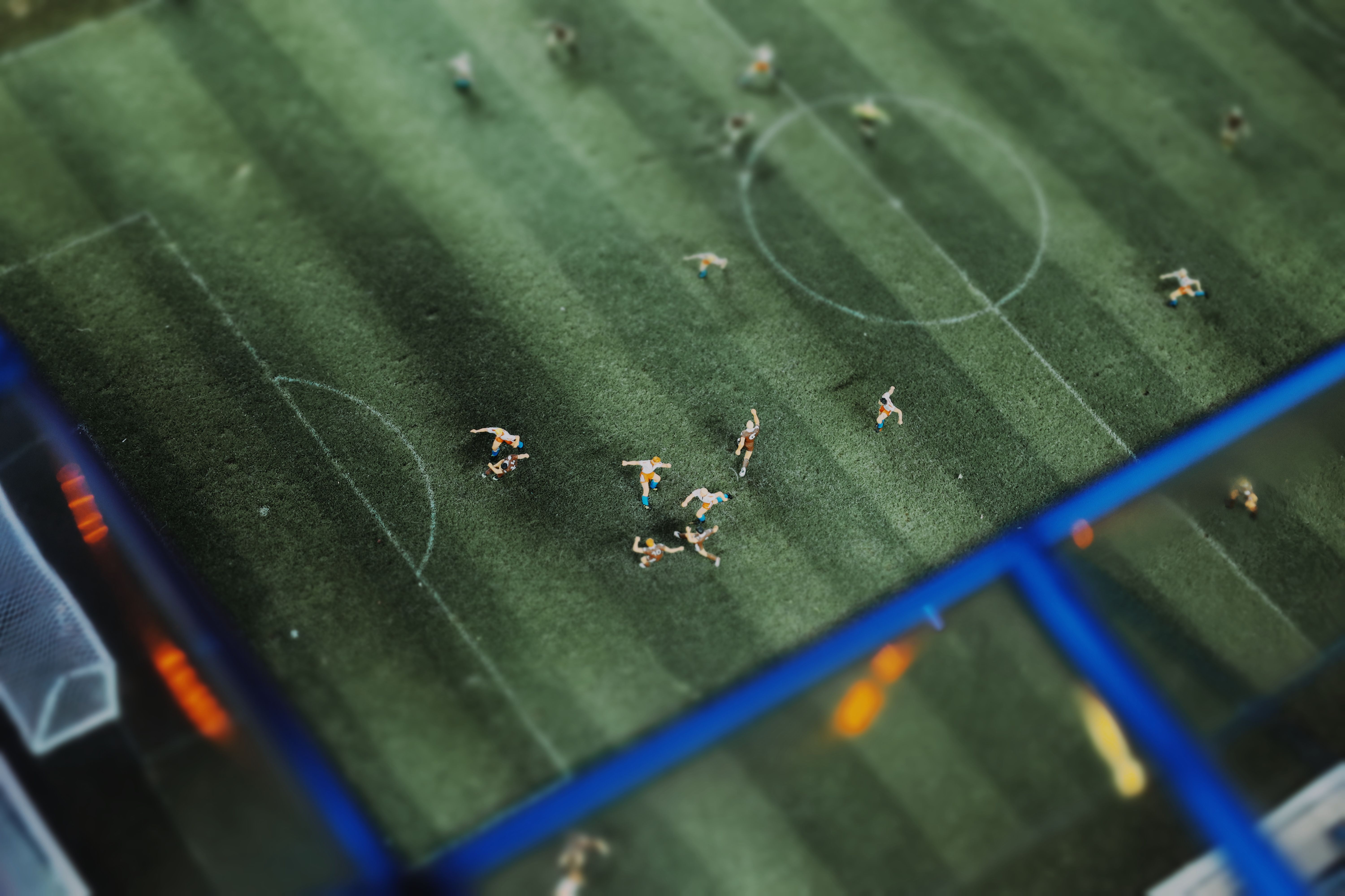Football Players Figurines on a Model · Free Stock Photo