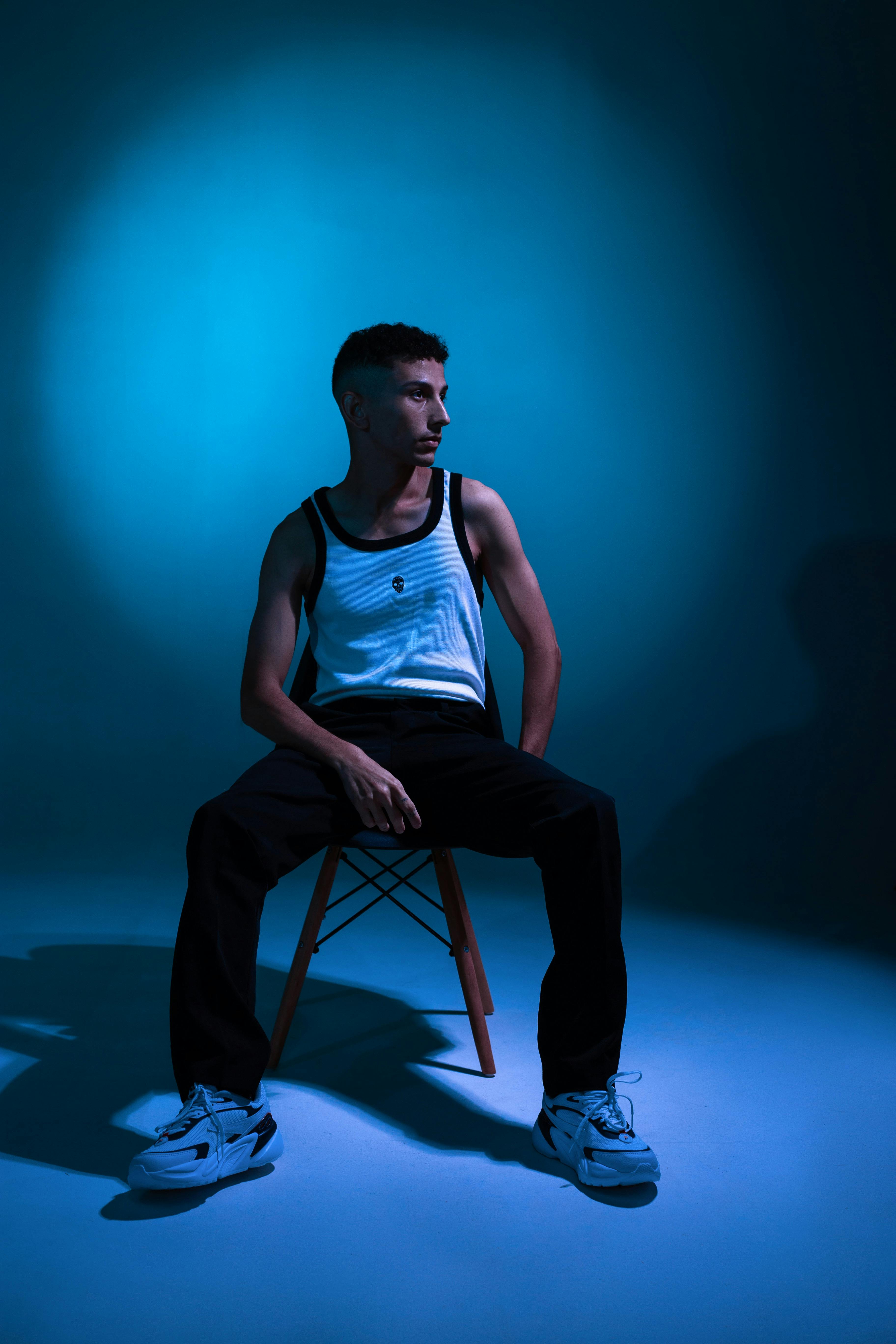 Man Posing on Chair in Shadow · Free Stock Photo