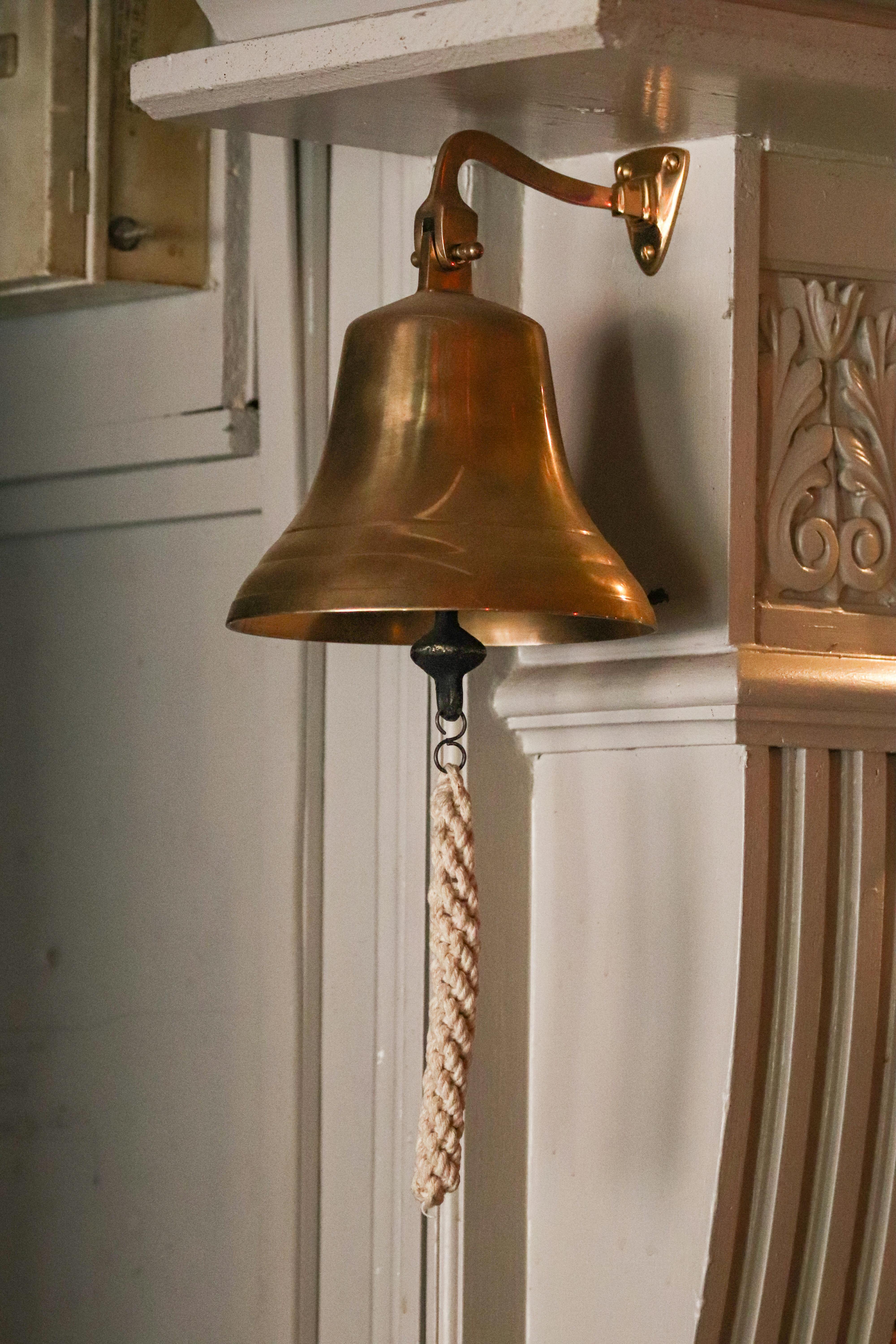 Brass Hanging Bell on a Wall · Free Stock Photo