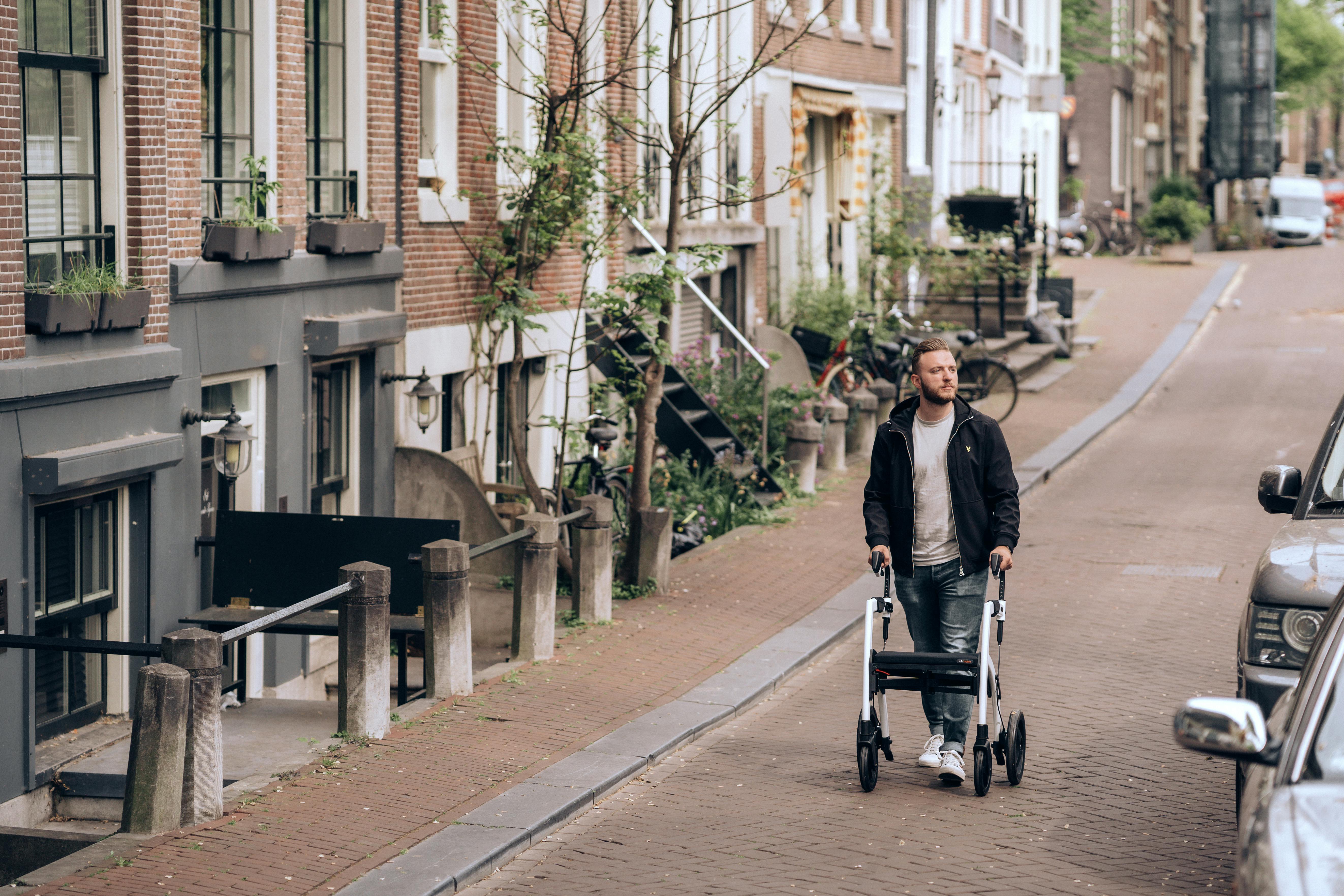 Man Walking with Walker on Street · Free Stock Photo