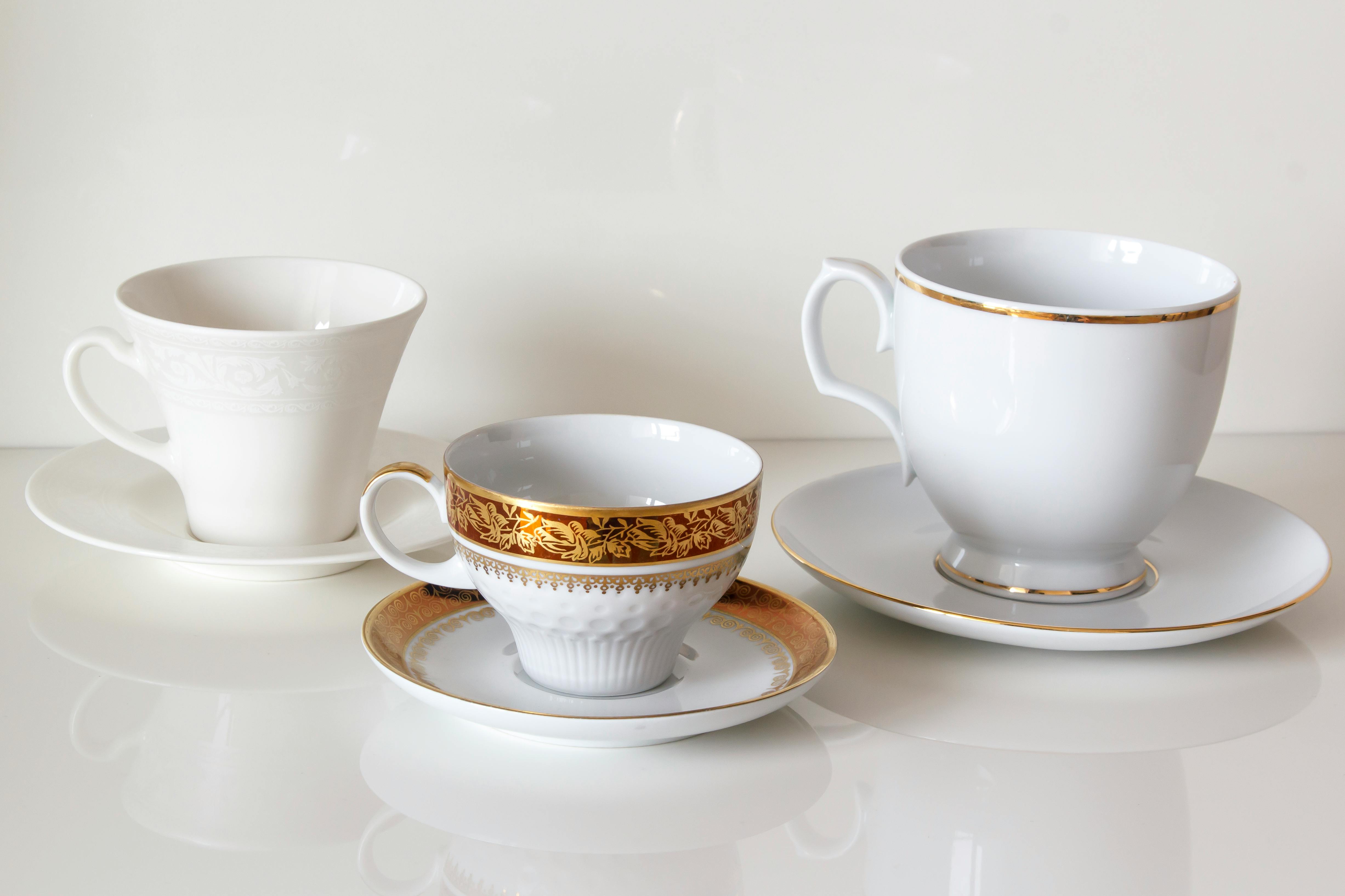 Creative white mugs on white surface · Free Stock Photo